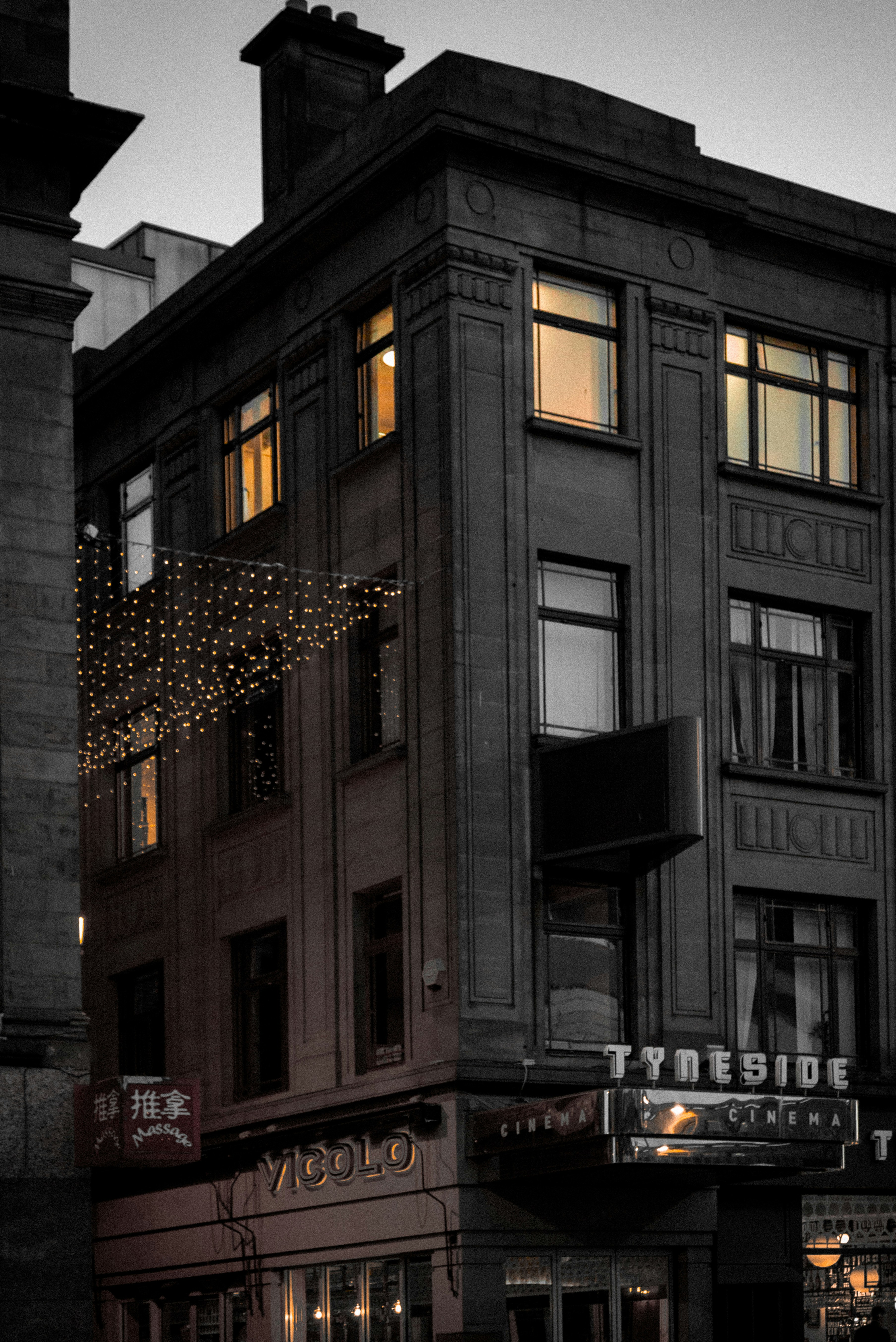 Historic building adorned with soft lights, showcasing the charm of urban architecture at dusk.