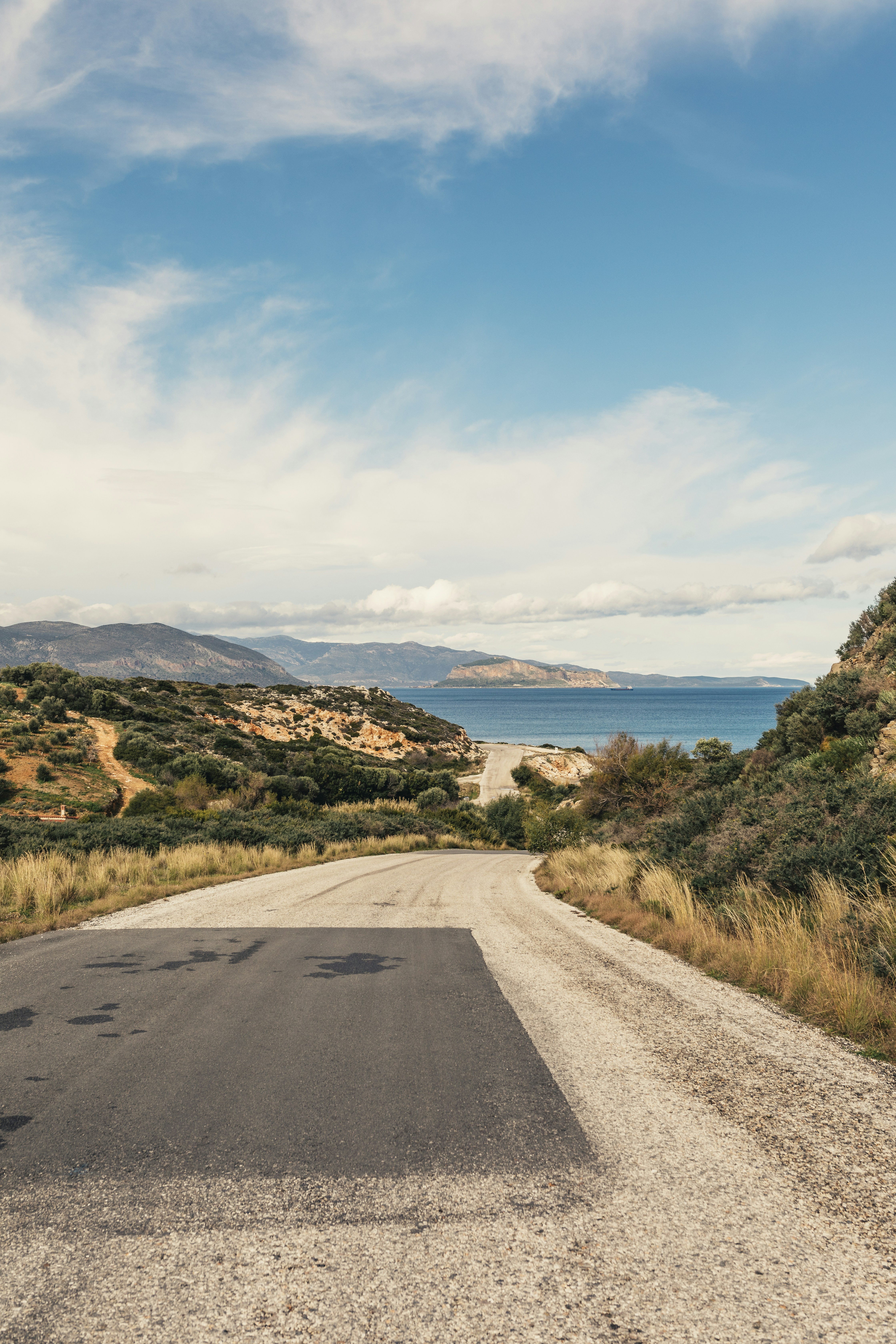 gray concrete road under clear blue sky