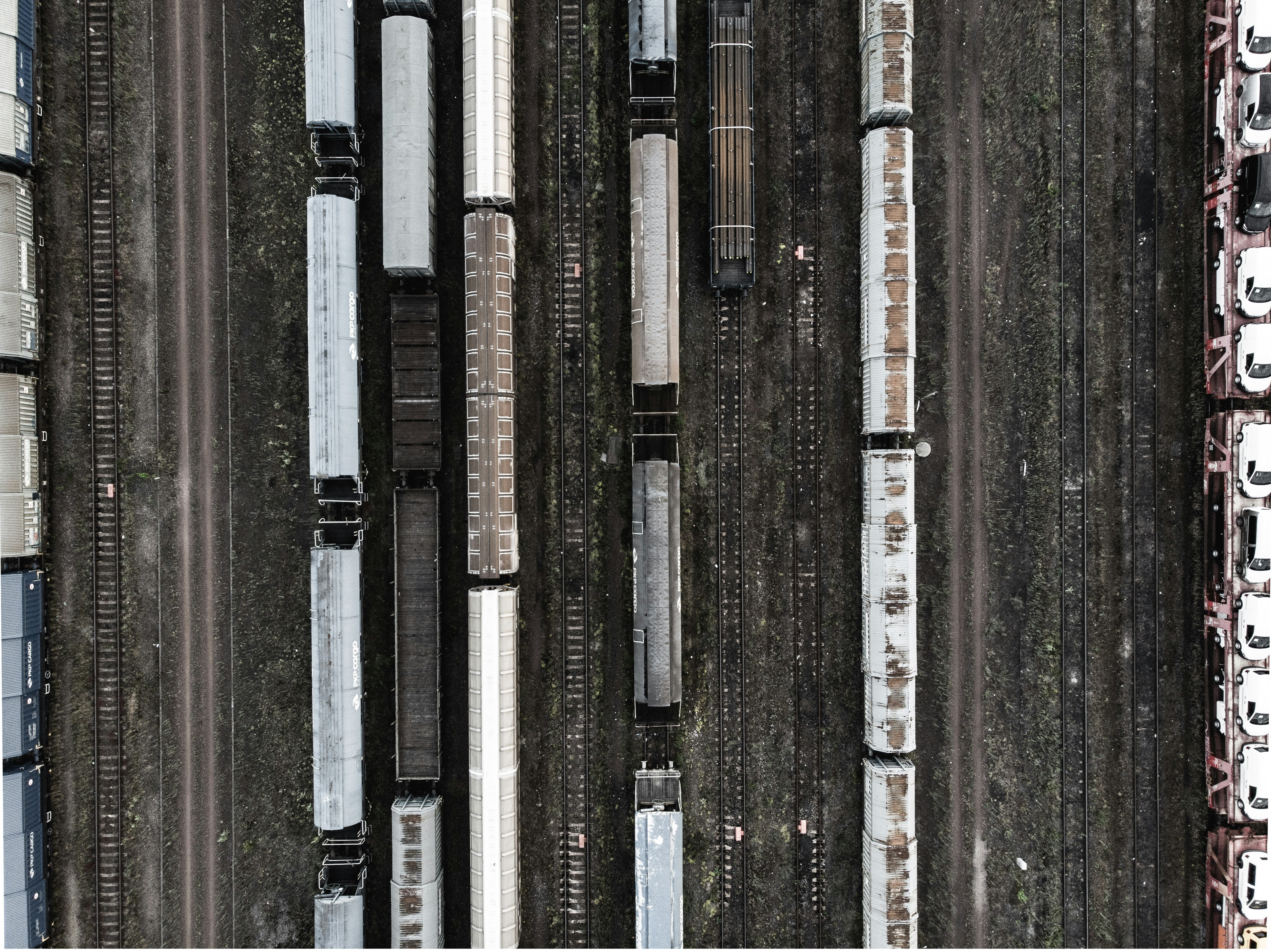Another aerial shot taken from my drone over a freight train station.  I saw that place from my car and I thought it could be looking more interesting from the air. The rust, the colors over there made it look like a train graveyard.I wish i could go higher with my drone, but in this case I had to follow the rules and fly responsible.  | top view of trains on railways