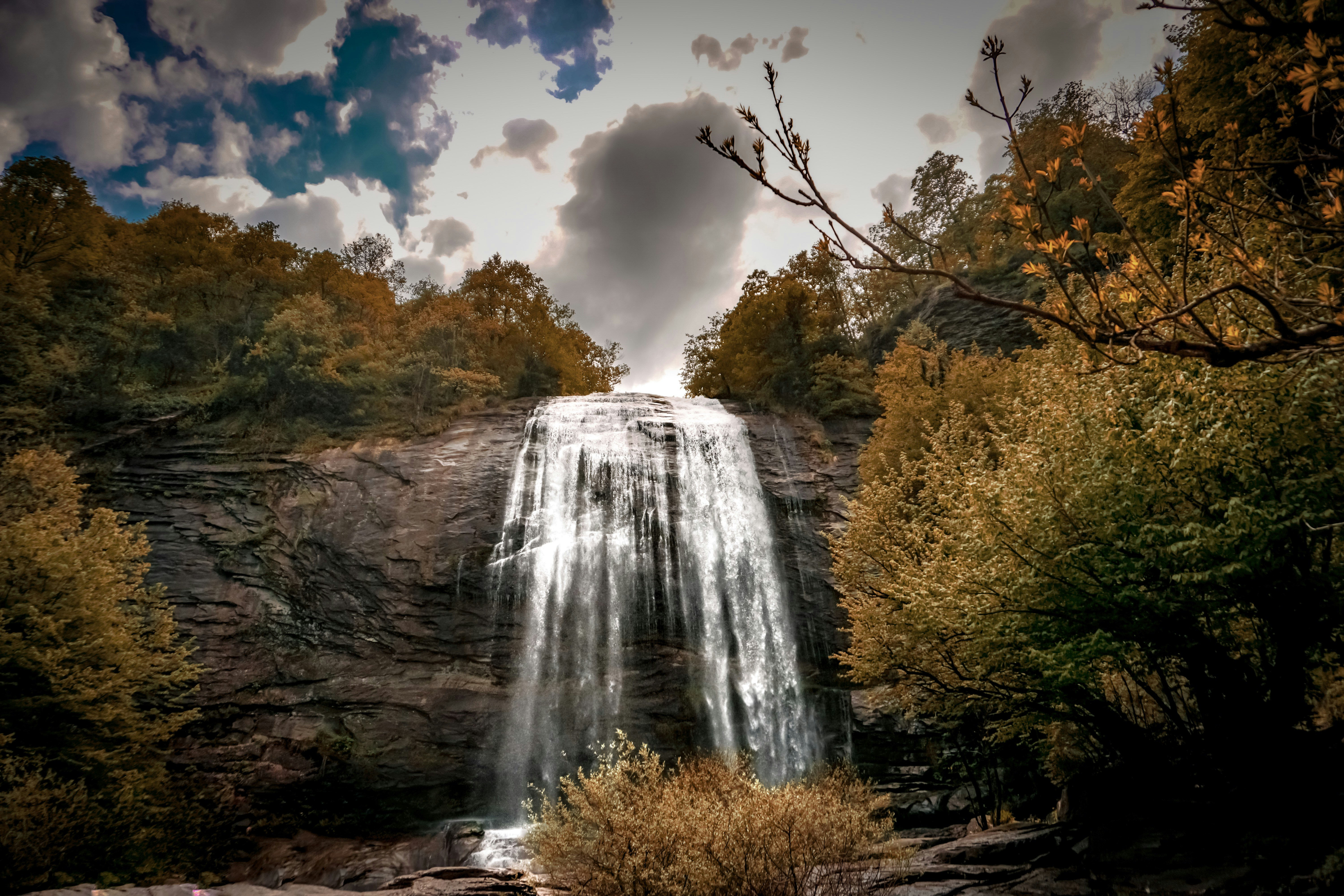 Autumn Cascade: Central Stream Descend Between Autumn Canopies