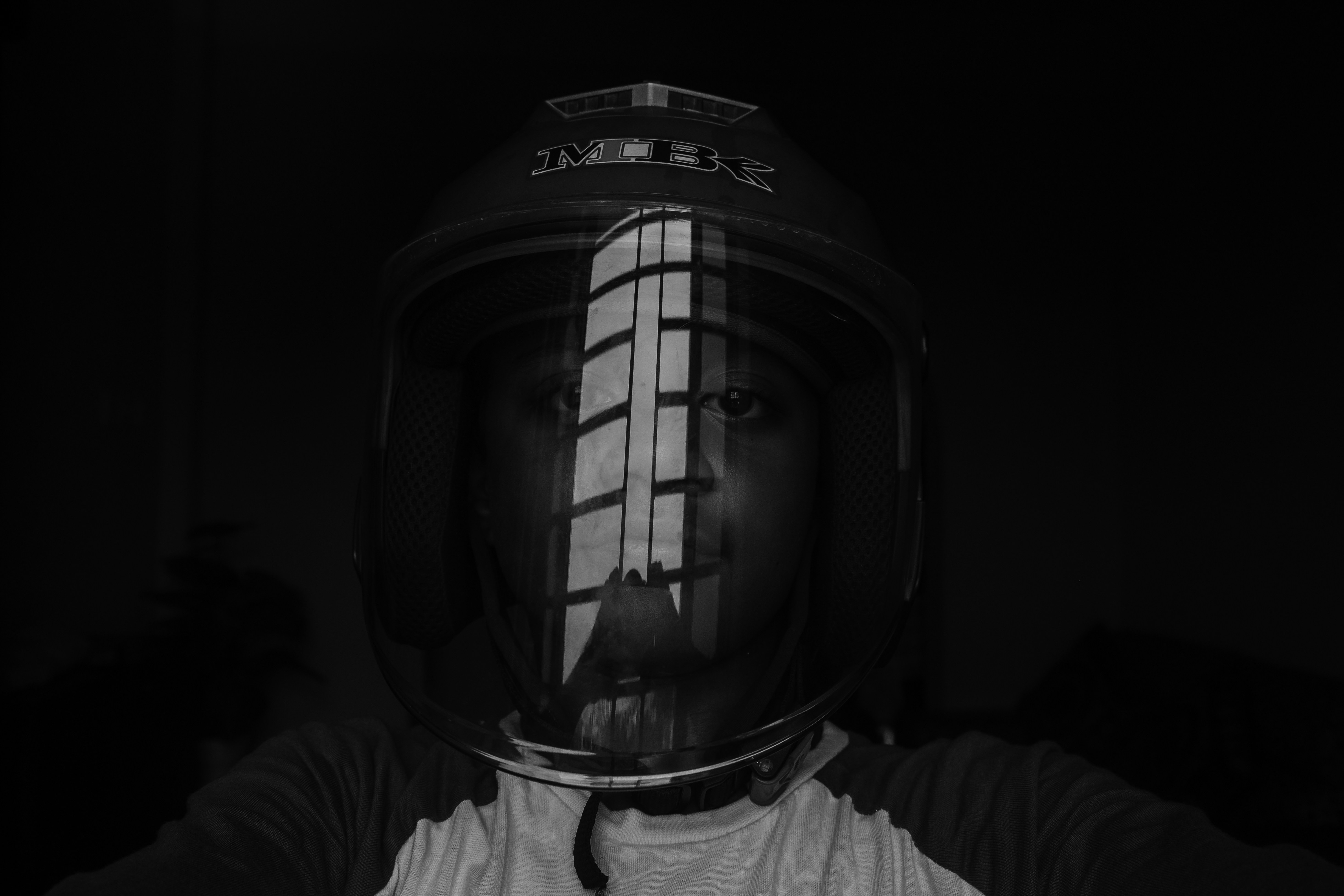 Cross-Pattern Reflections in a Low-Light Helmet Portrait