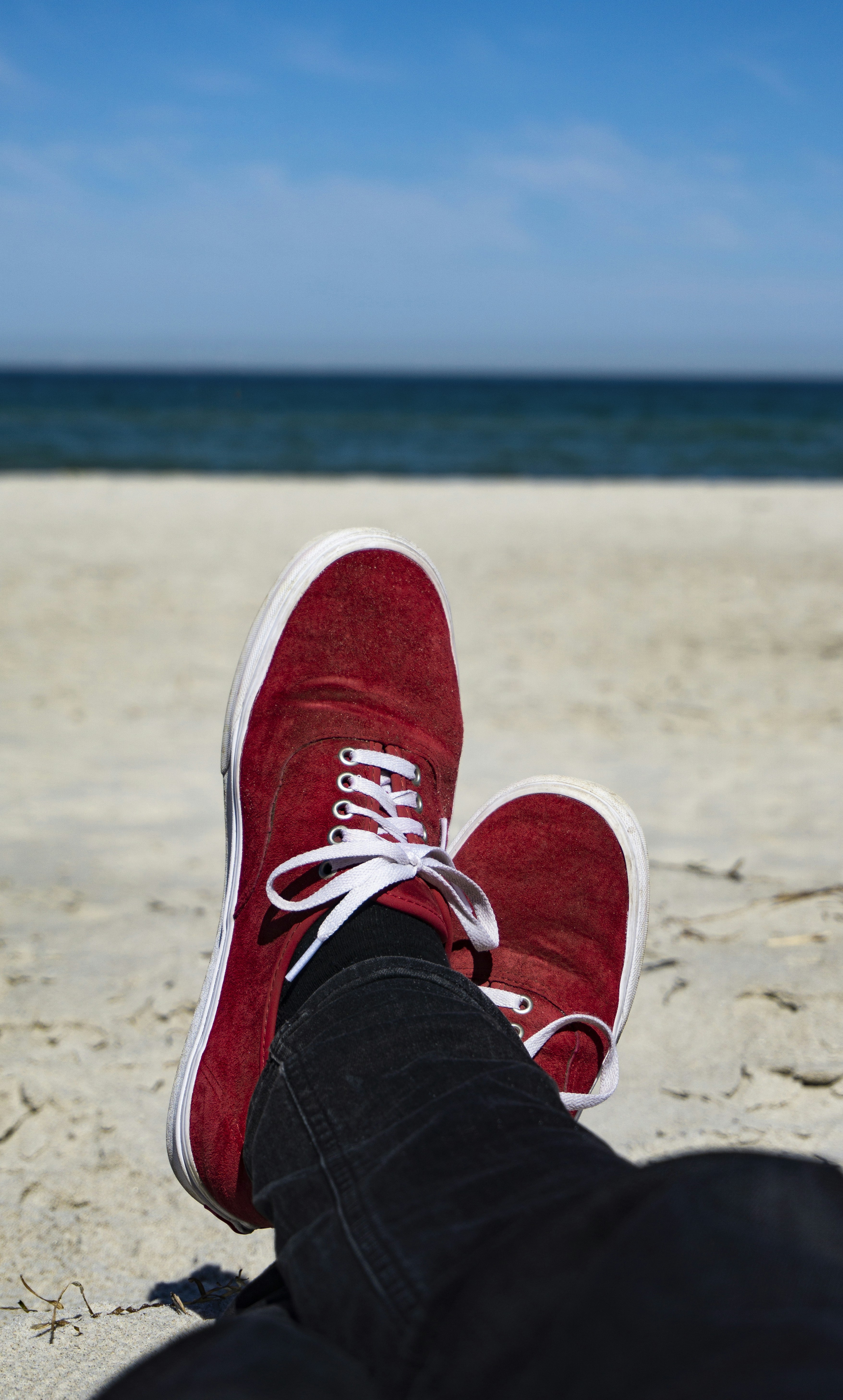 Crimson Sneakers on Sunlit Sand: A Quiet Beachside Pause