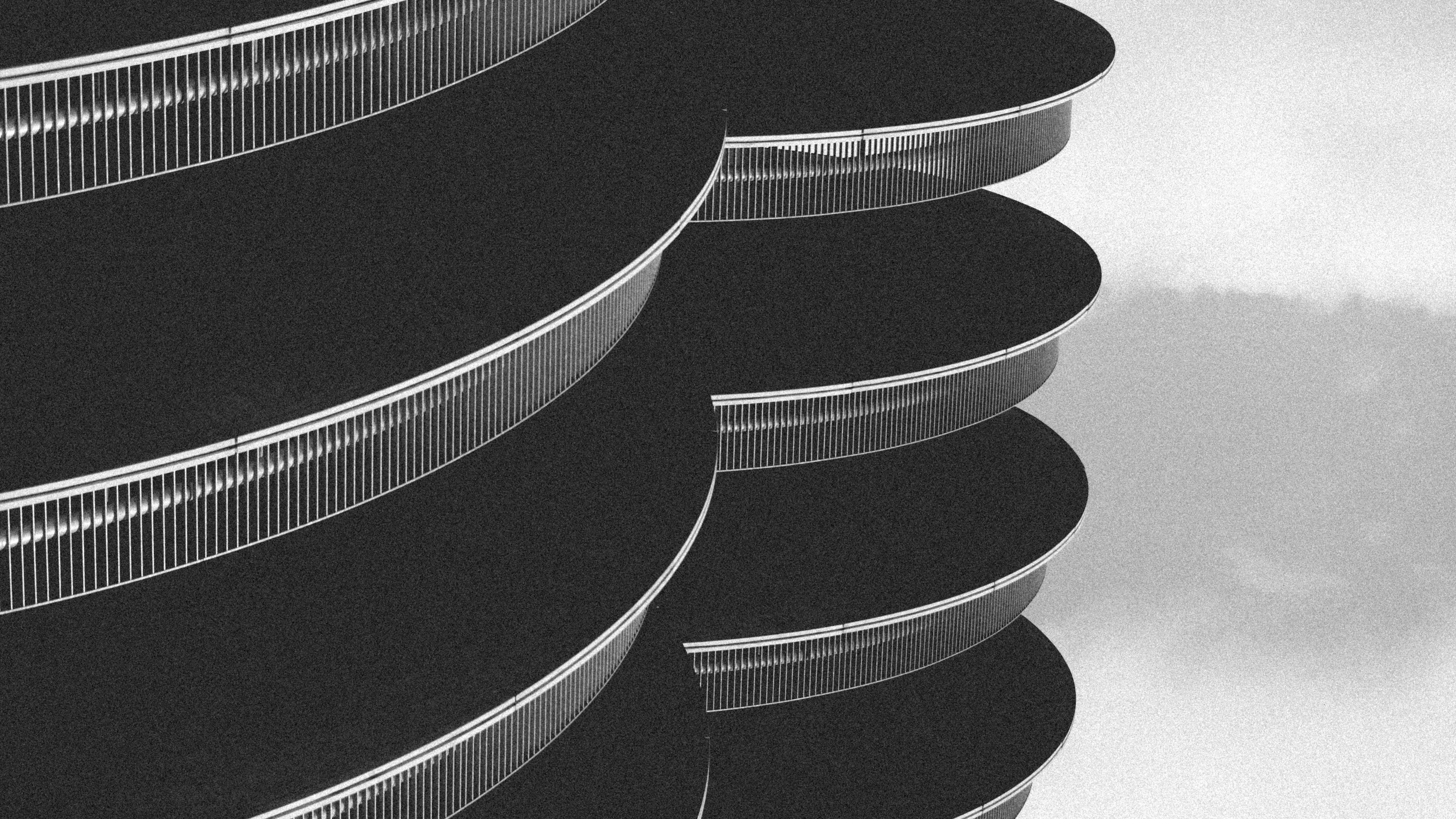 Abstract view of overlapping circular balconies with contrasting light and shadow.