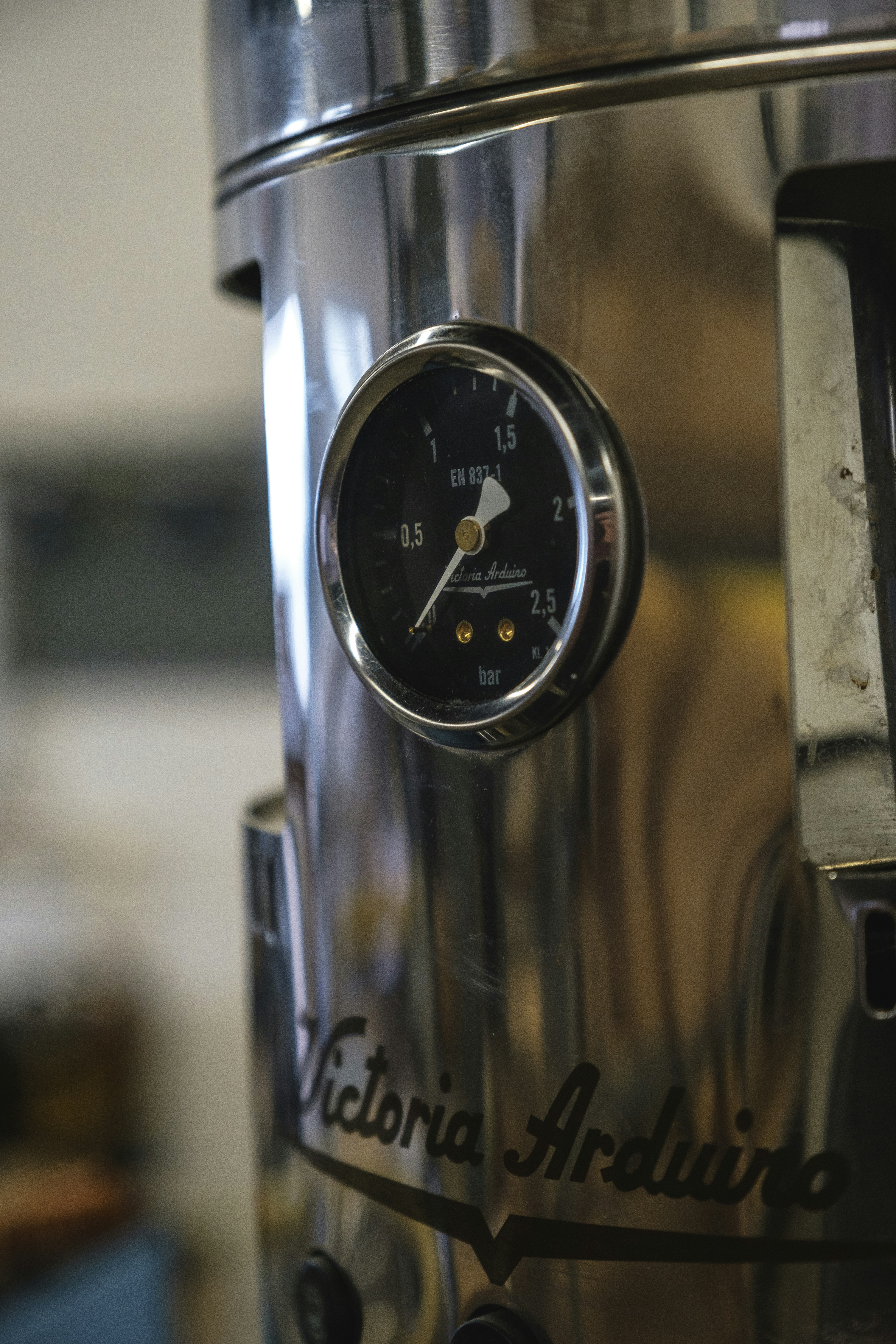 Close-up of a pressure gauge on a Victoria Arduino espresso machine, showcasing the intricate design and functionality essential for perfect brewing.
