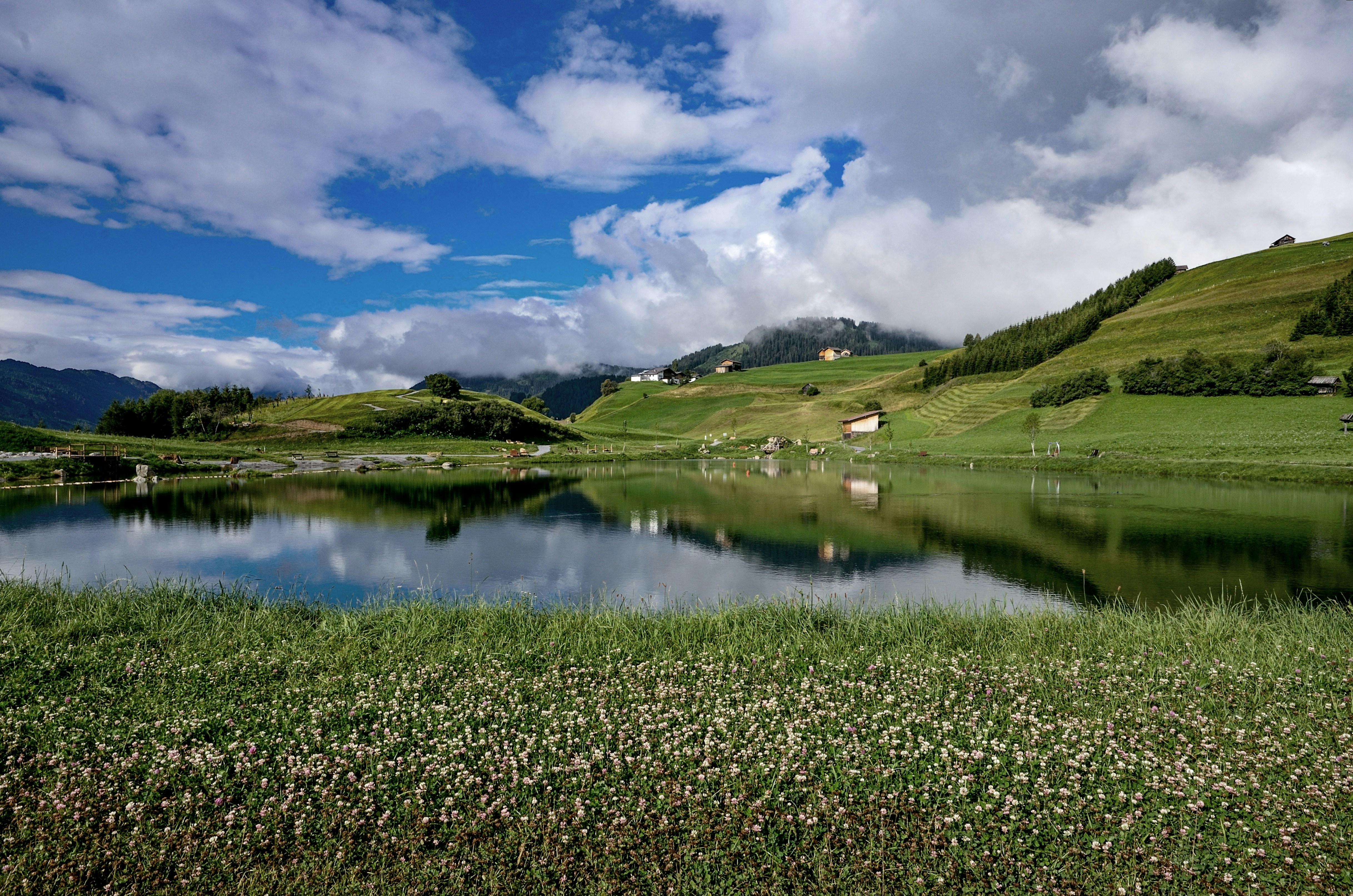 Lake surrounded by grass field photo – Free Fiss Image on Unsplash