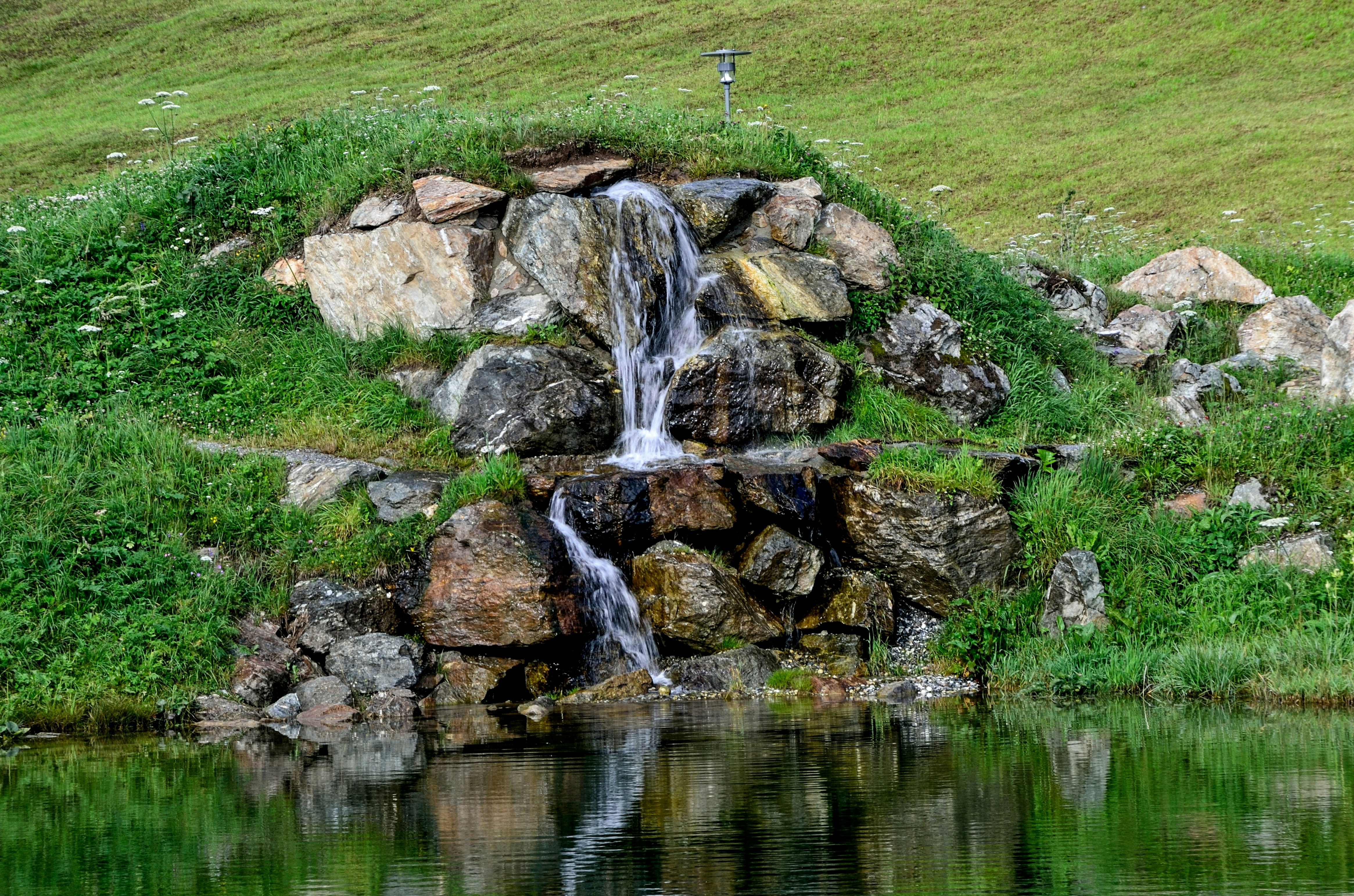 Mossy Stone Cascade into a Quiet Mirror Pond