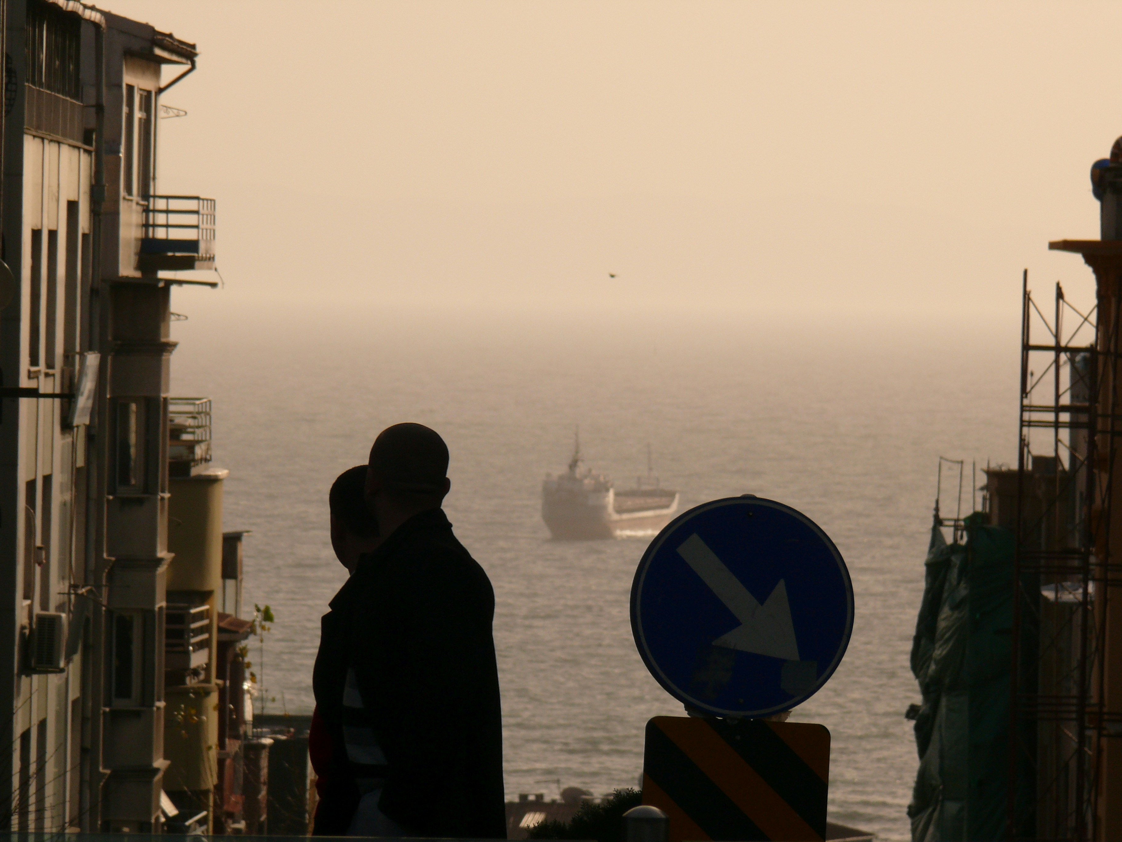 Toward Light: A Ship Breaking the Horizon Between Alleyways