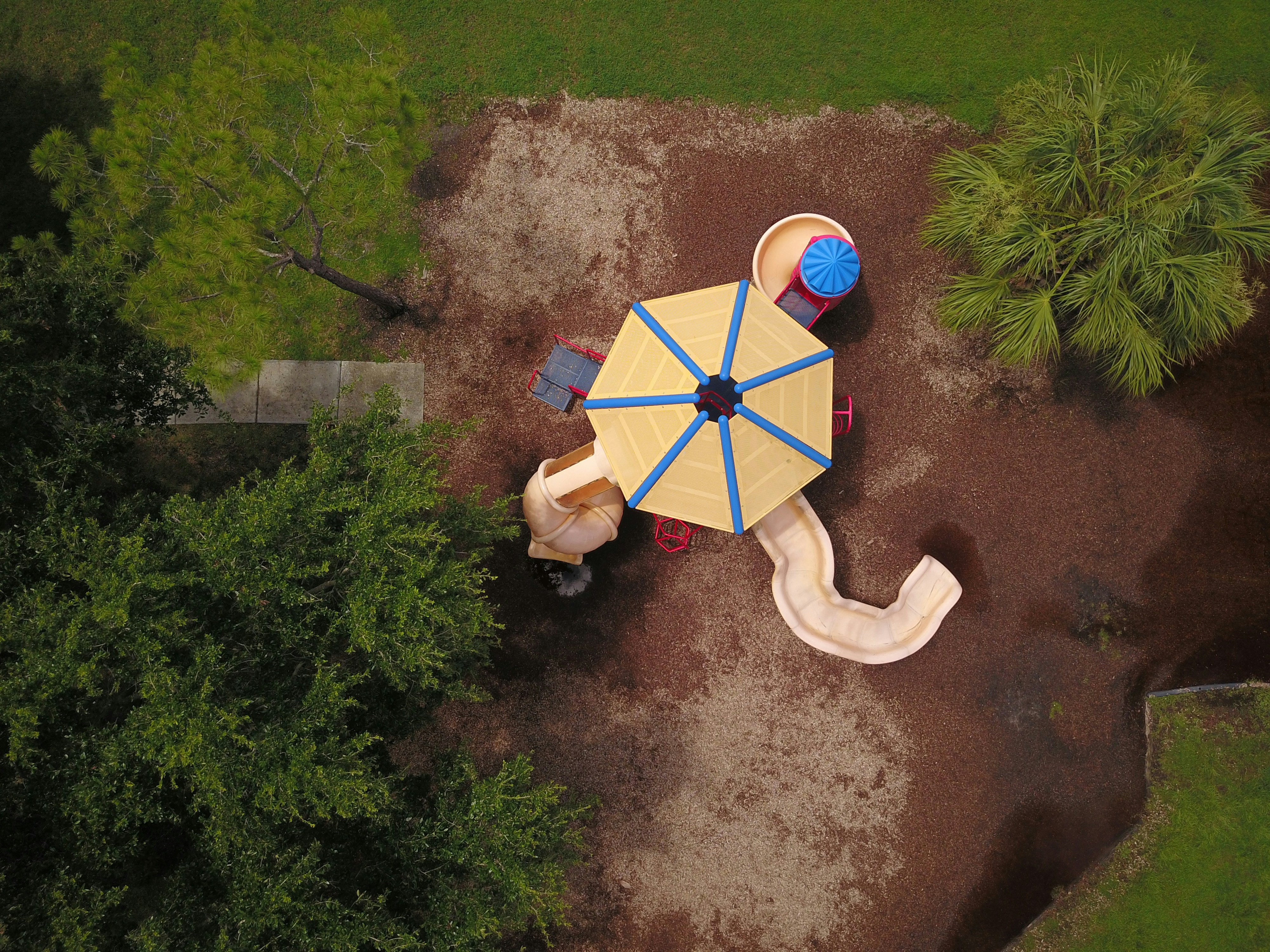 Hexagonal Shade and Curved Slide: Aerial Playground Portrait
