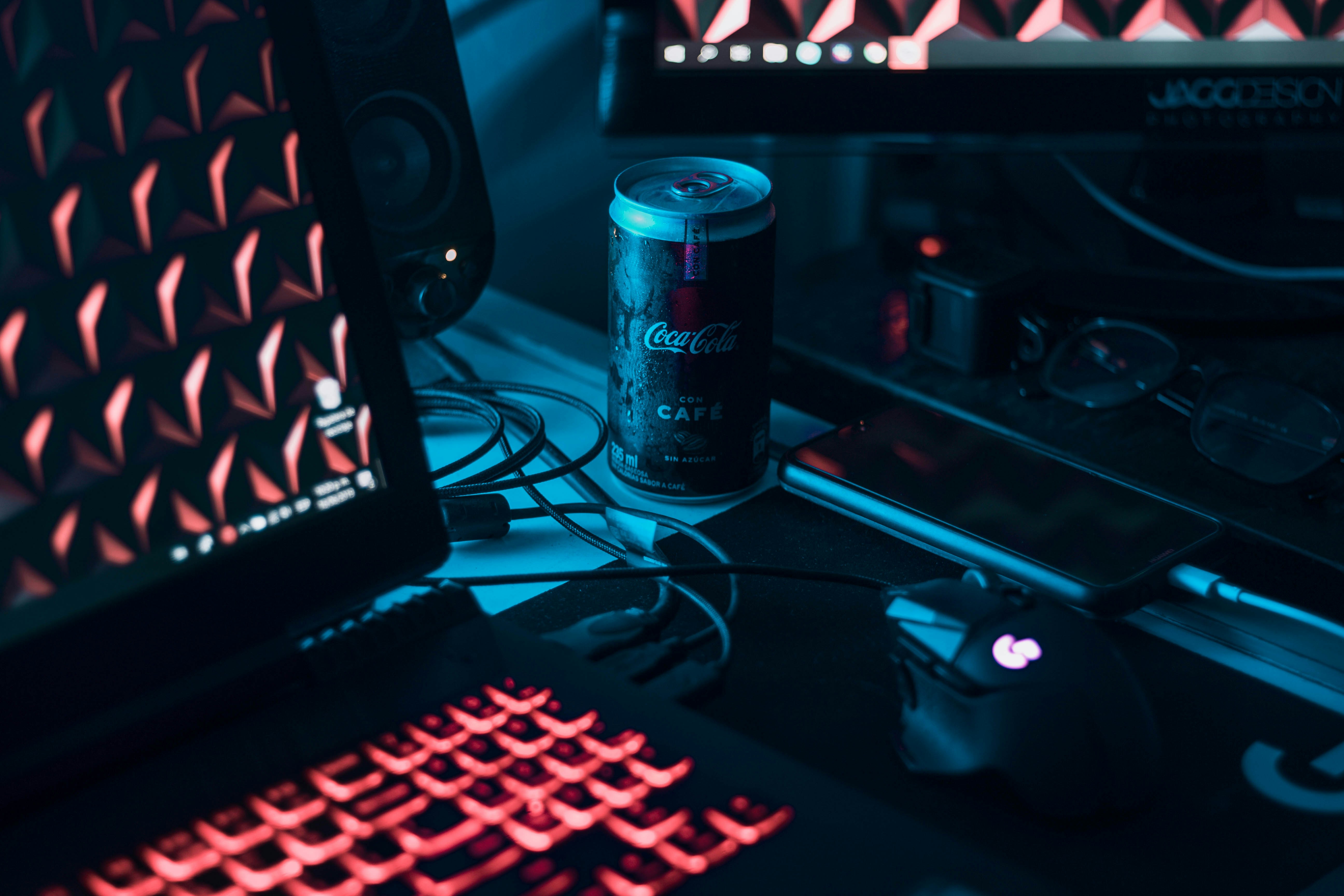 Blue Hour Focus: Coca-Cola Can Anchors a Red-Backlit Tech Desk