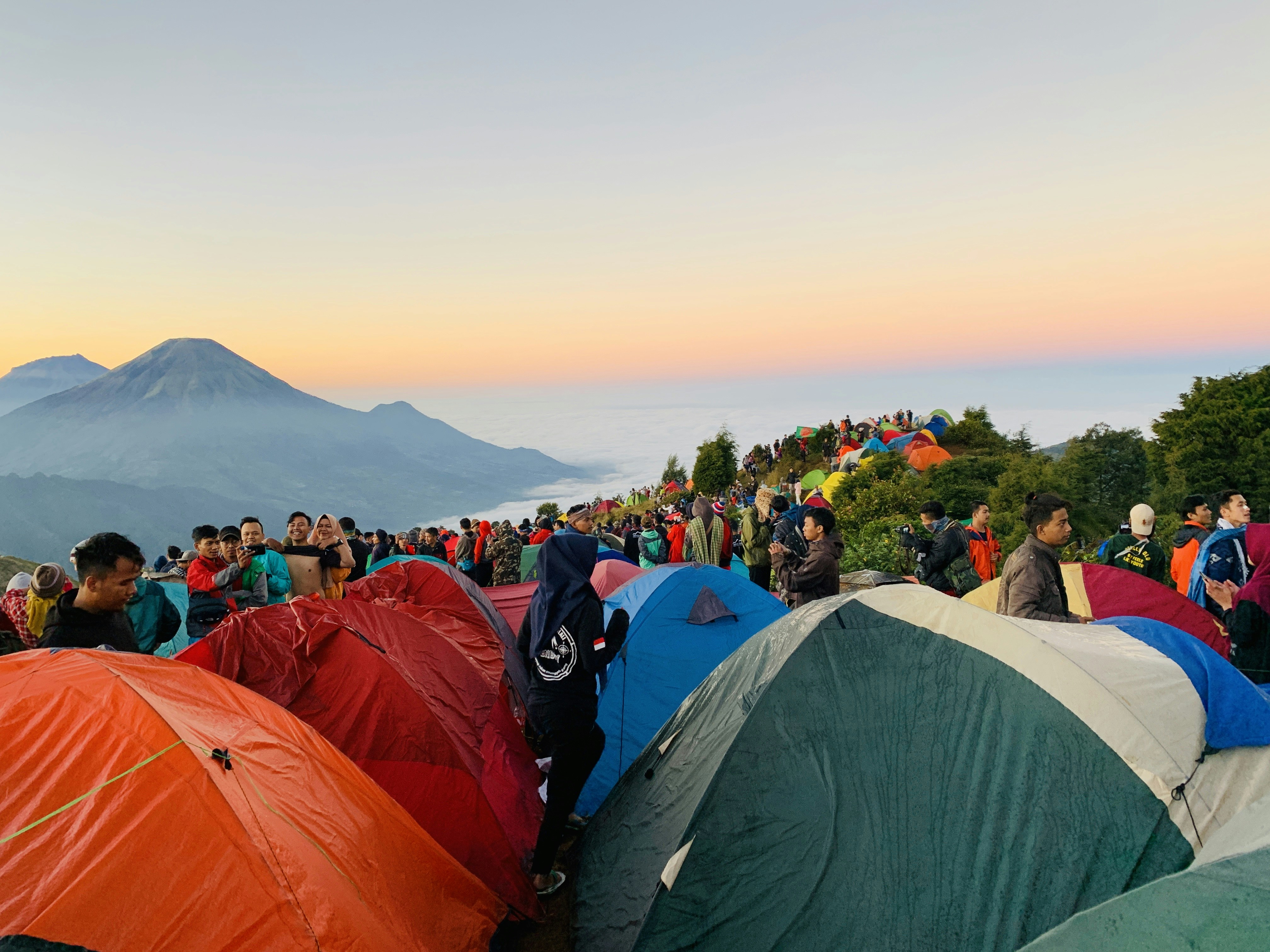 Dawn on the Volcano Ridge: A Tapestry of Tents and People