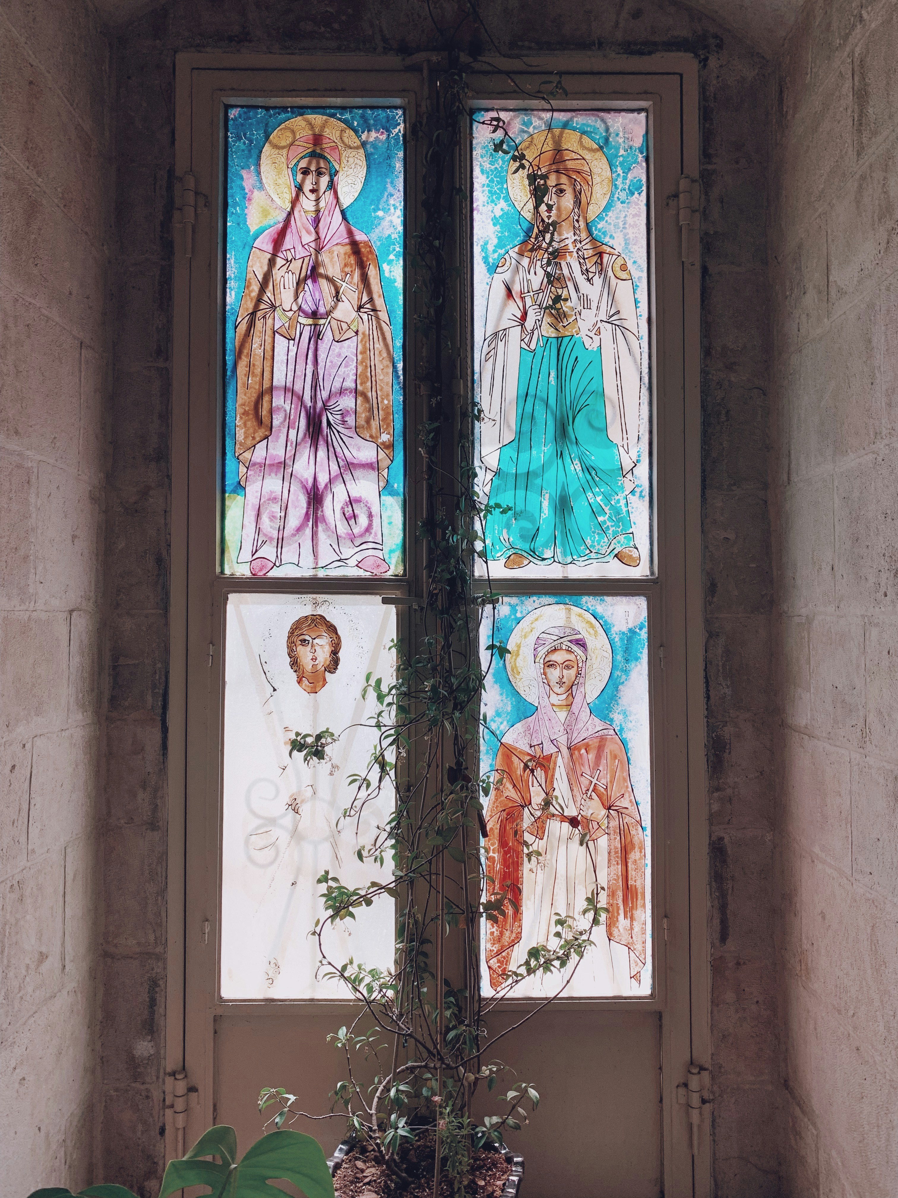 Stained-Glass Trinity: A Verdant Vines Frame the Holy Panels