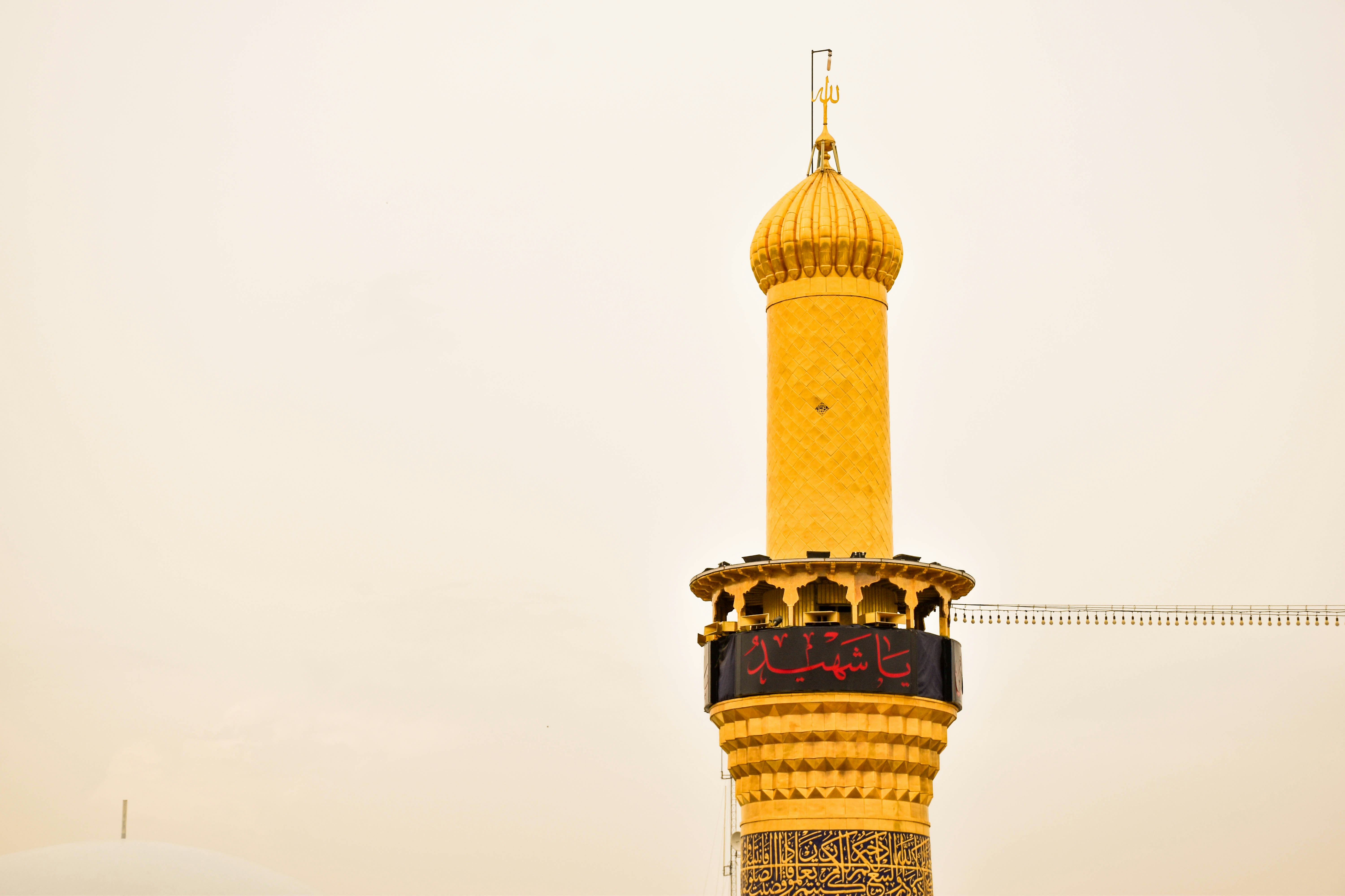 Golden Minaret Crown: Quiet Dawn Above a Pale Sky