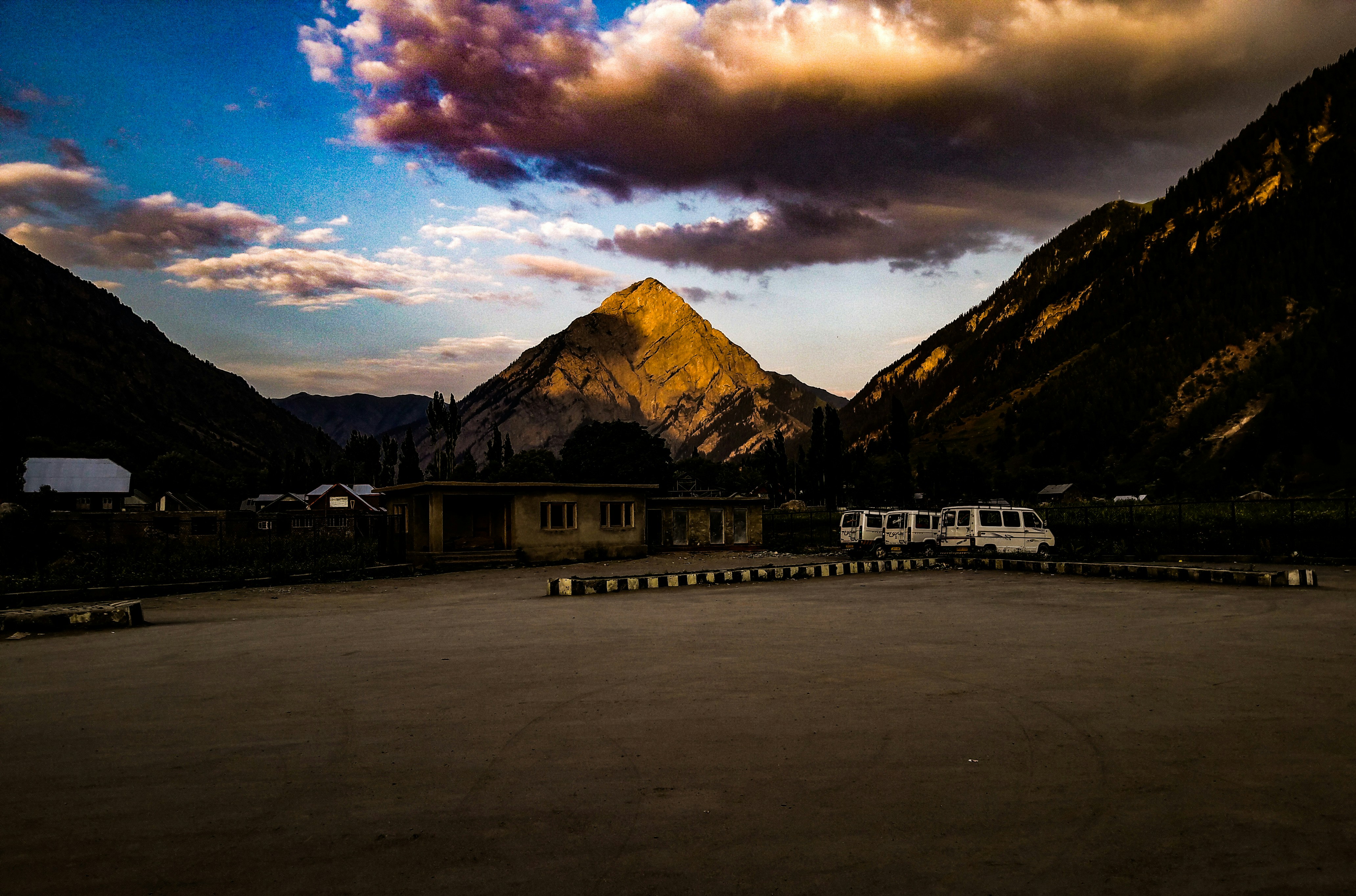 Sunlit Peak Over a Quiet Mountain Village Plaza
