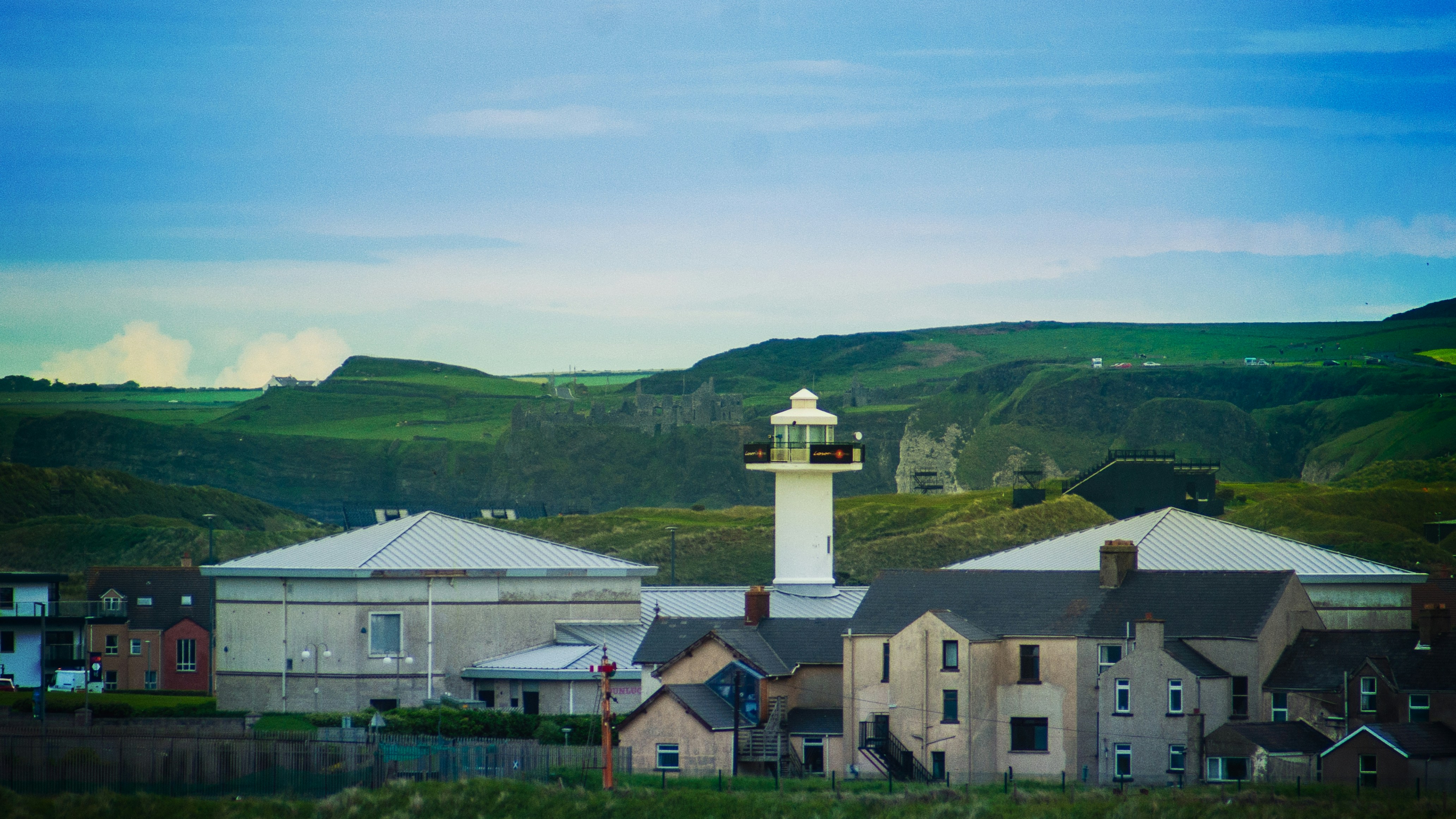 Lighthouse Crowned by Distant Cliffs