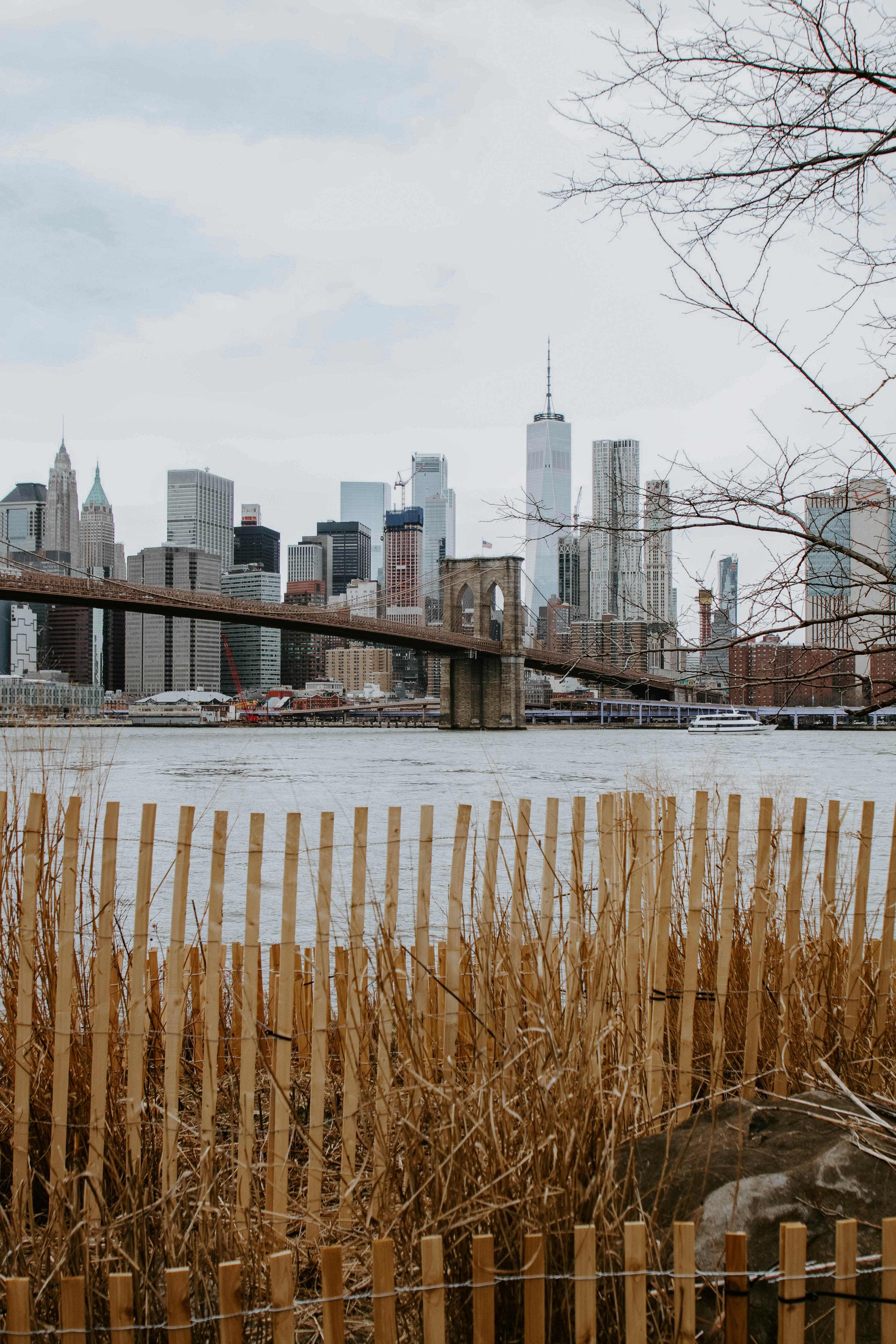 Bridge Between River and Sky: A Fence-Framed Manhattan Panorama