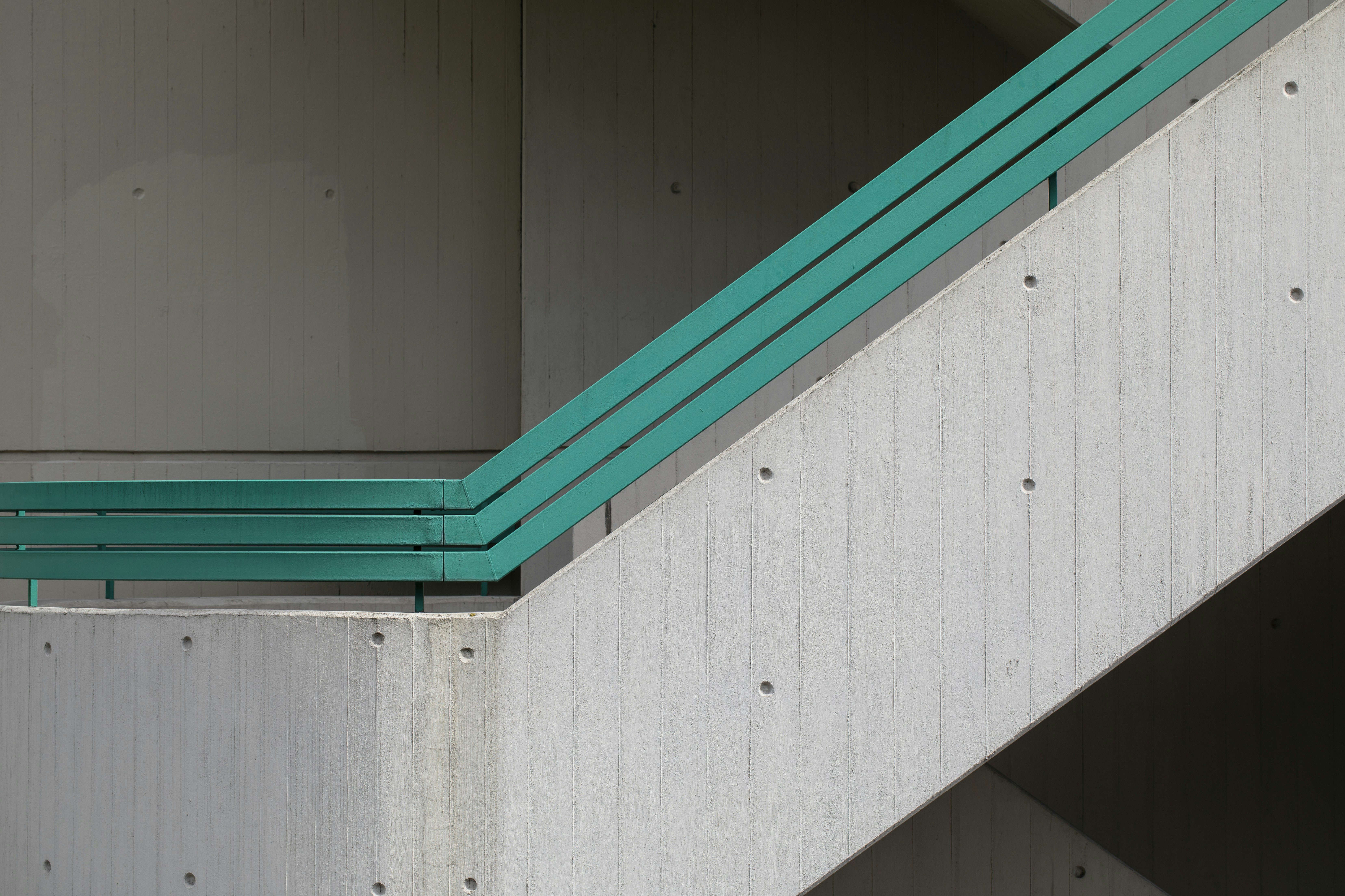 Teal Rail Crossing: Geometric Concrete and Striking Angles