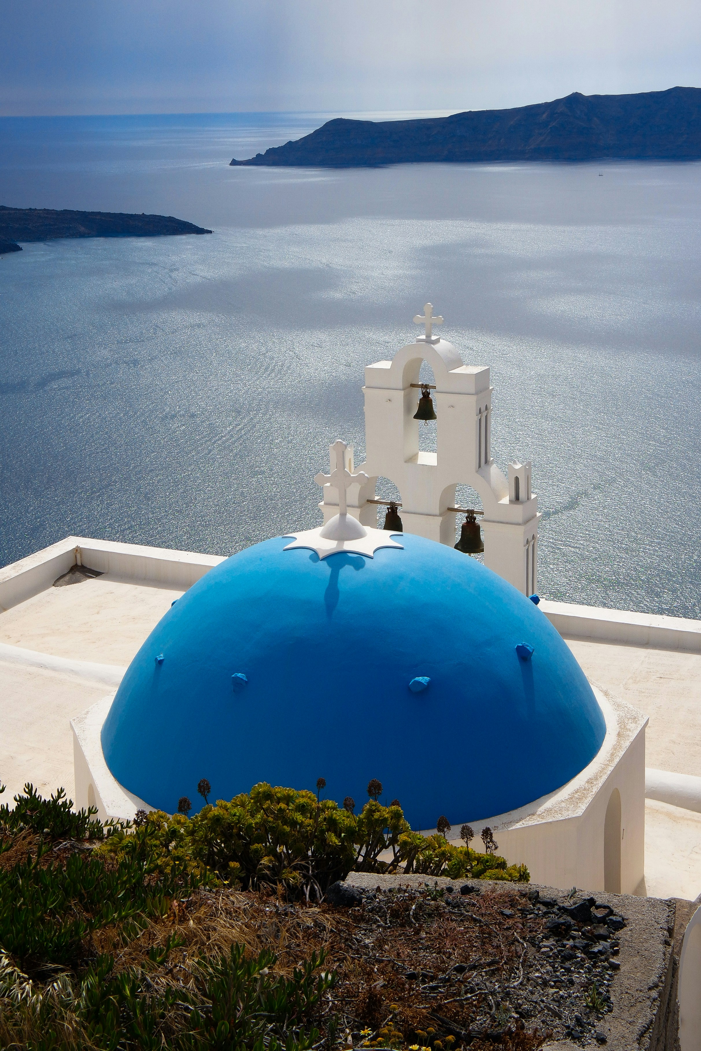 Blue Dome Sanctuary: Santorini’s Aegean Crown Framed by the Bell Tower