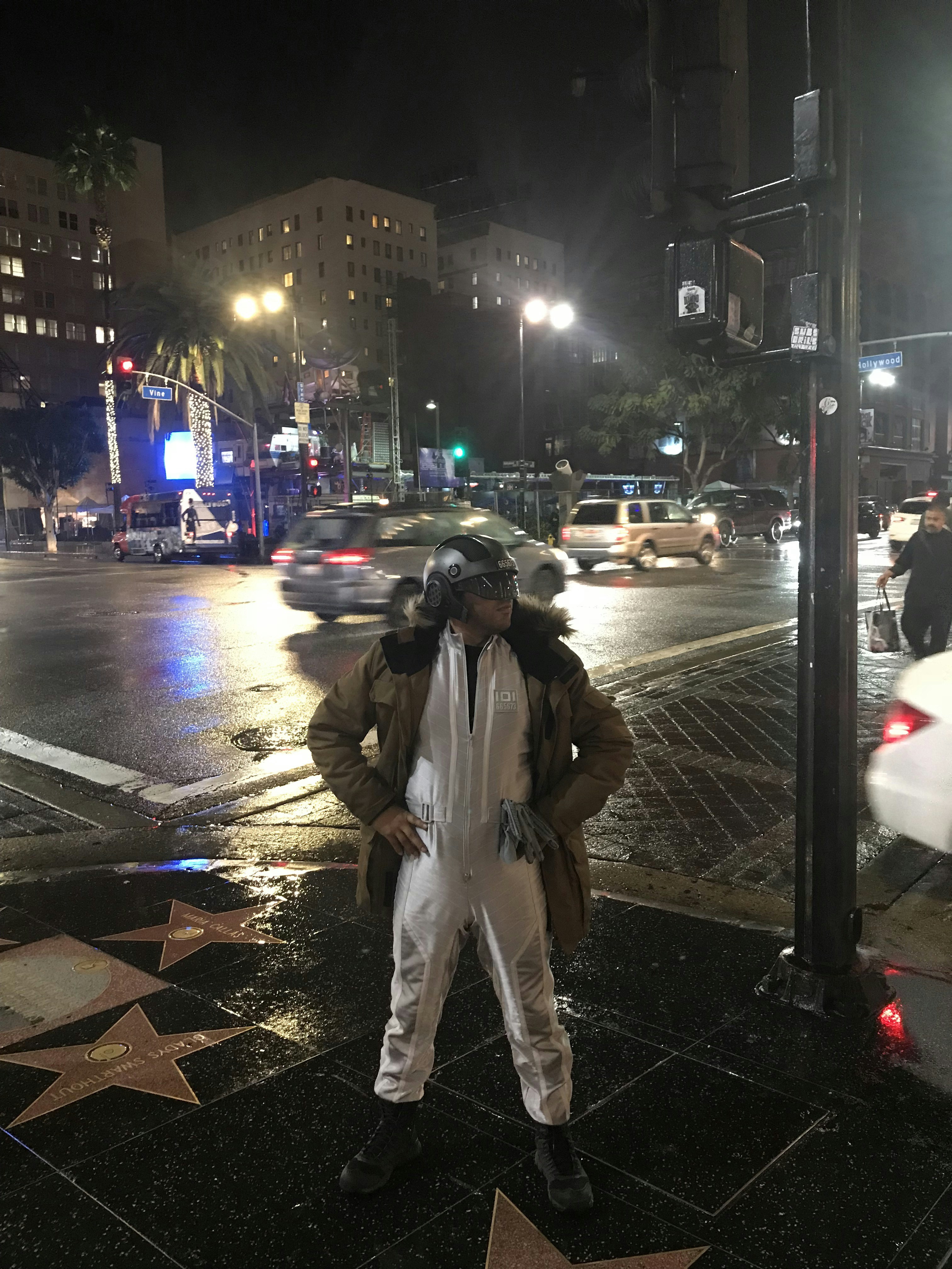 Midnight Halo on the Hollywood Walk of Fame: White-Suited Stance in Rain