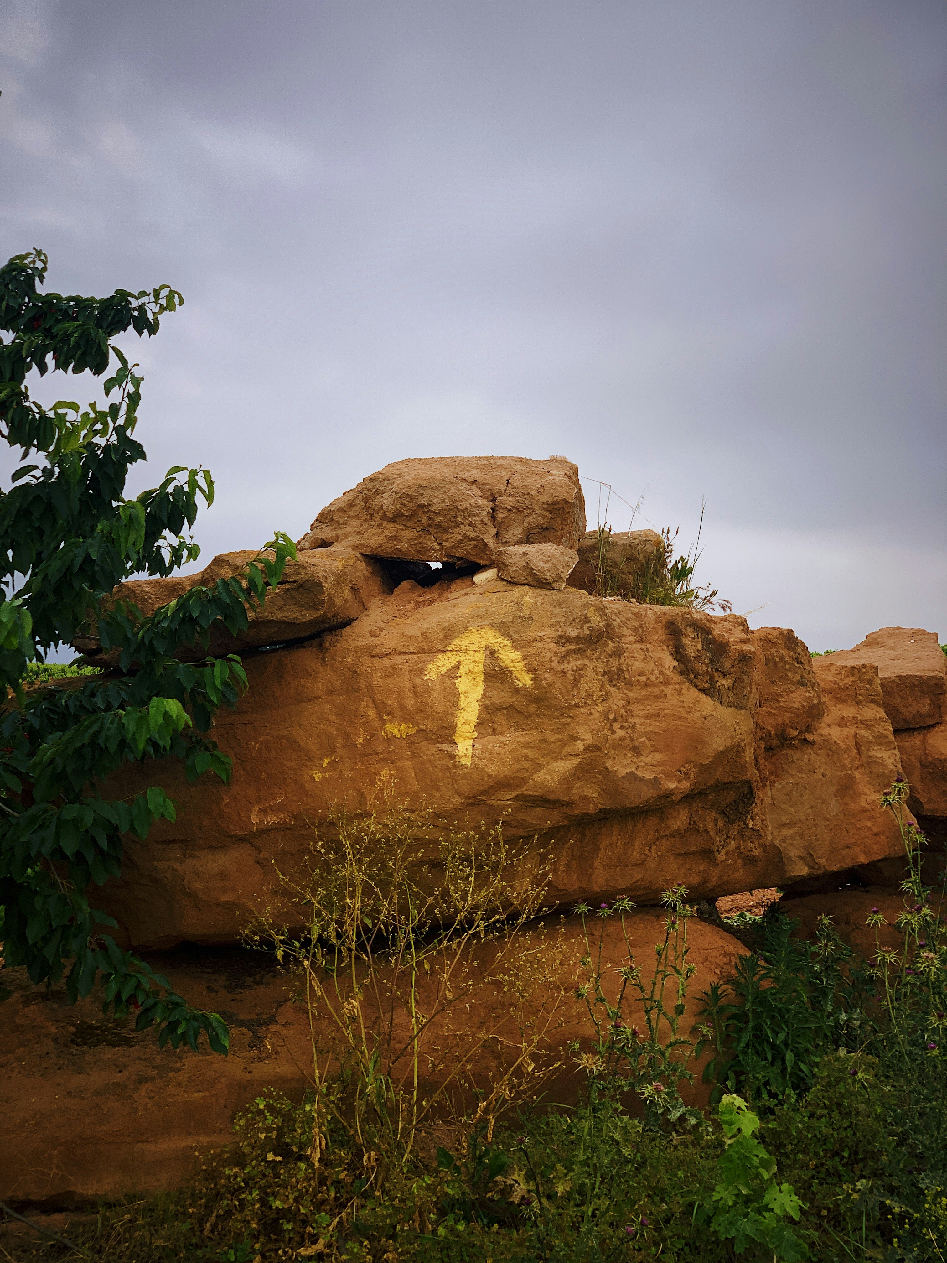 Upward Arrow on a Weathered Red Outcrop