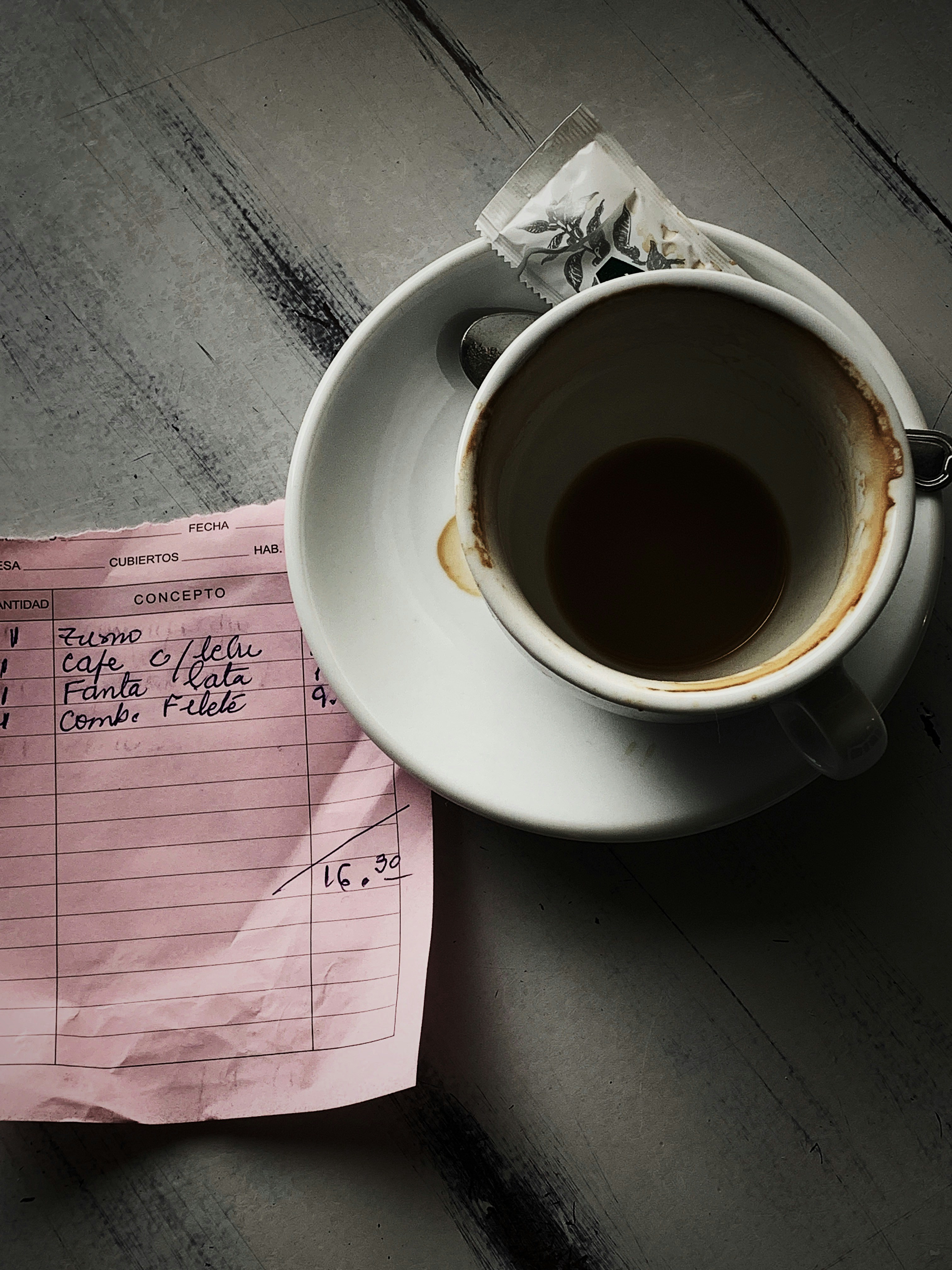 Espresso Pause on a Weathered Table with a Pink Receipt