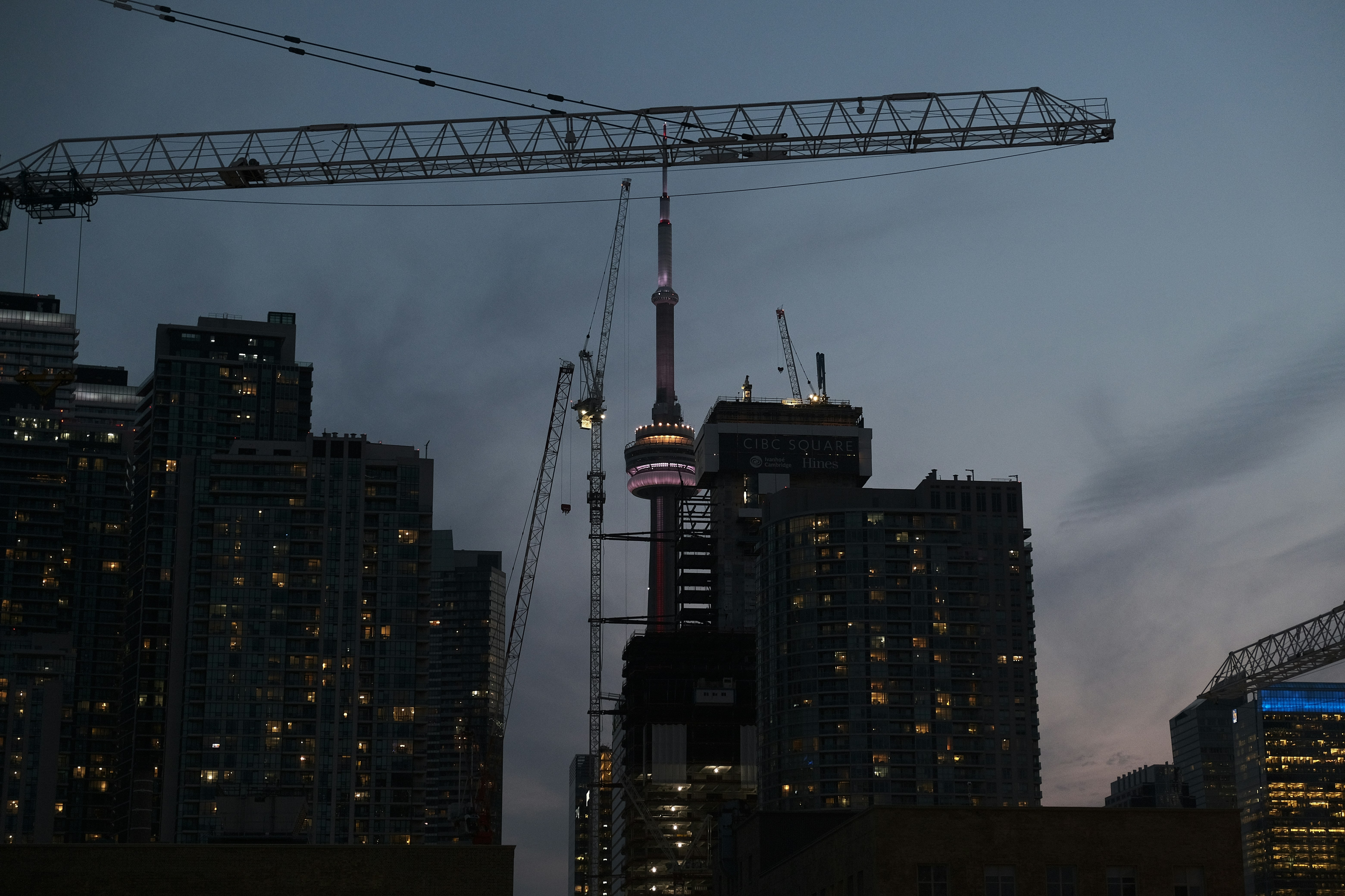 Crane Choir Over a Pink-Capped Tower at Dusk