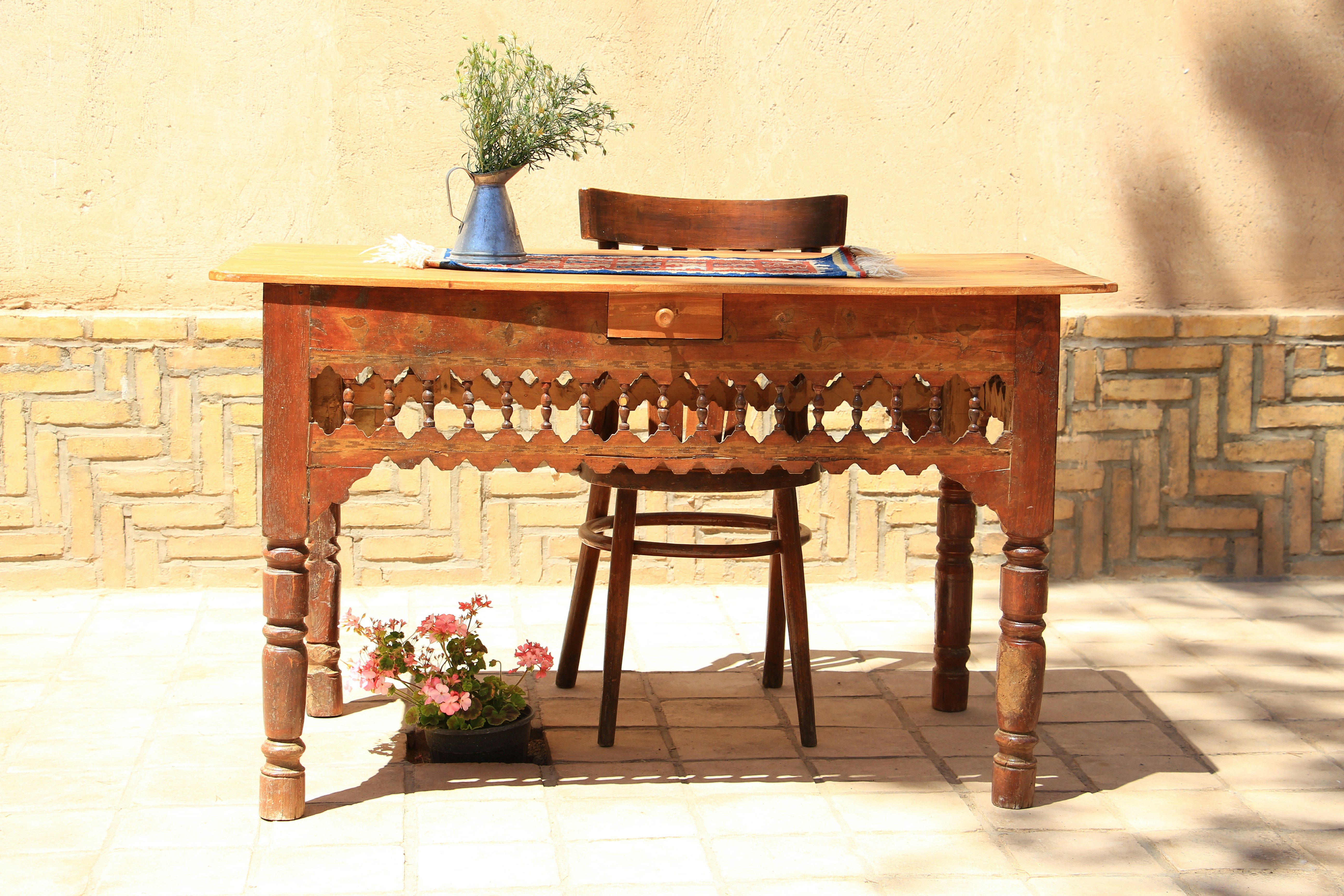 Sunlit Rustic Table: An Antique Still Life in a Courtyard