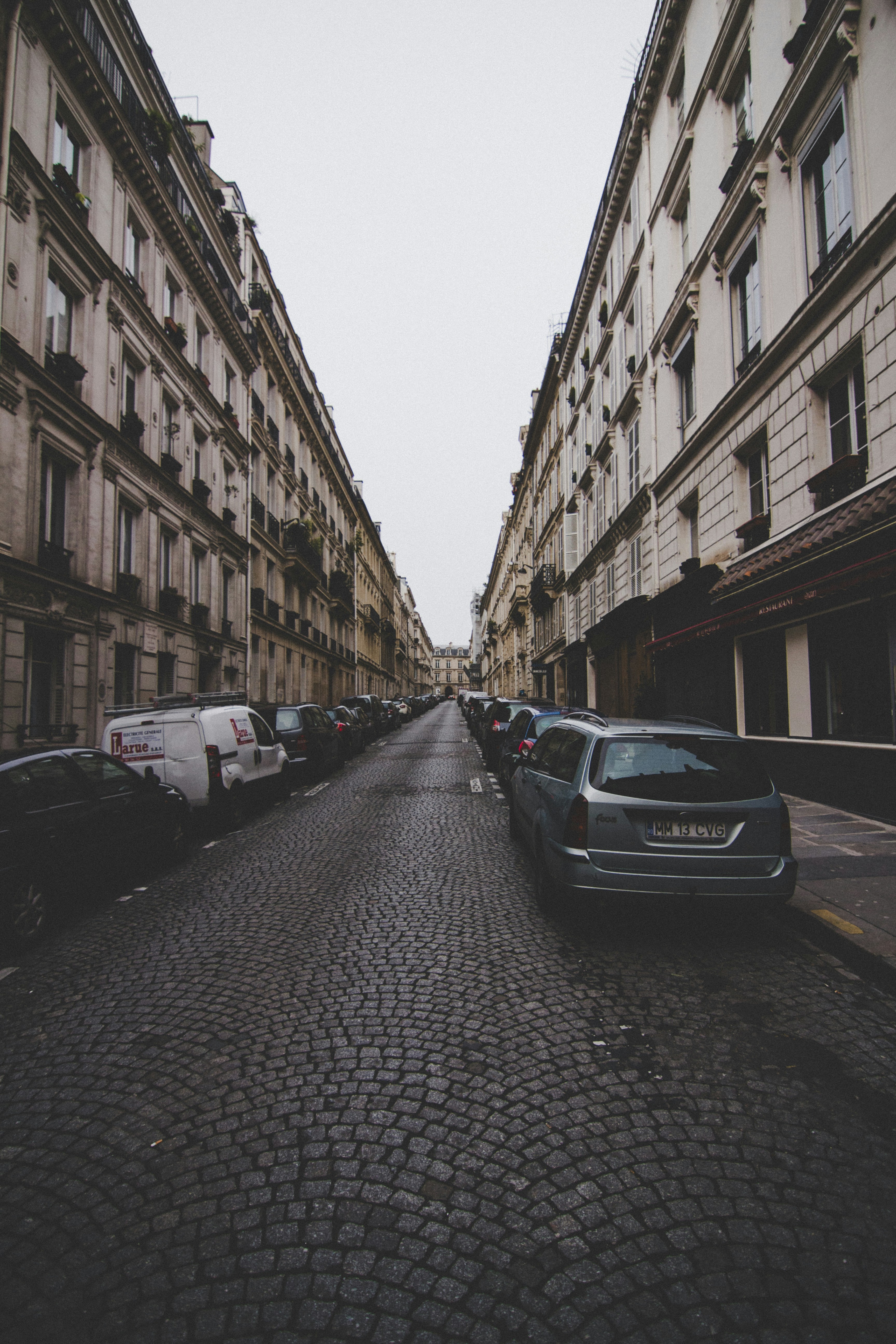 Car lot in a road between buildings during daytime photo – Free Grey ...
