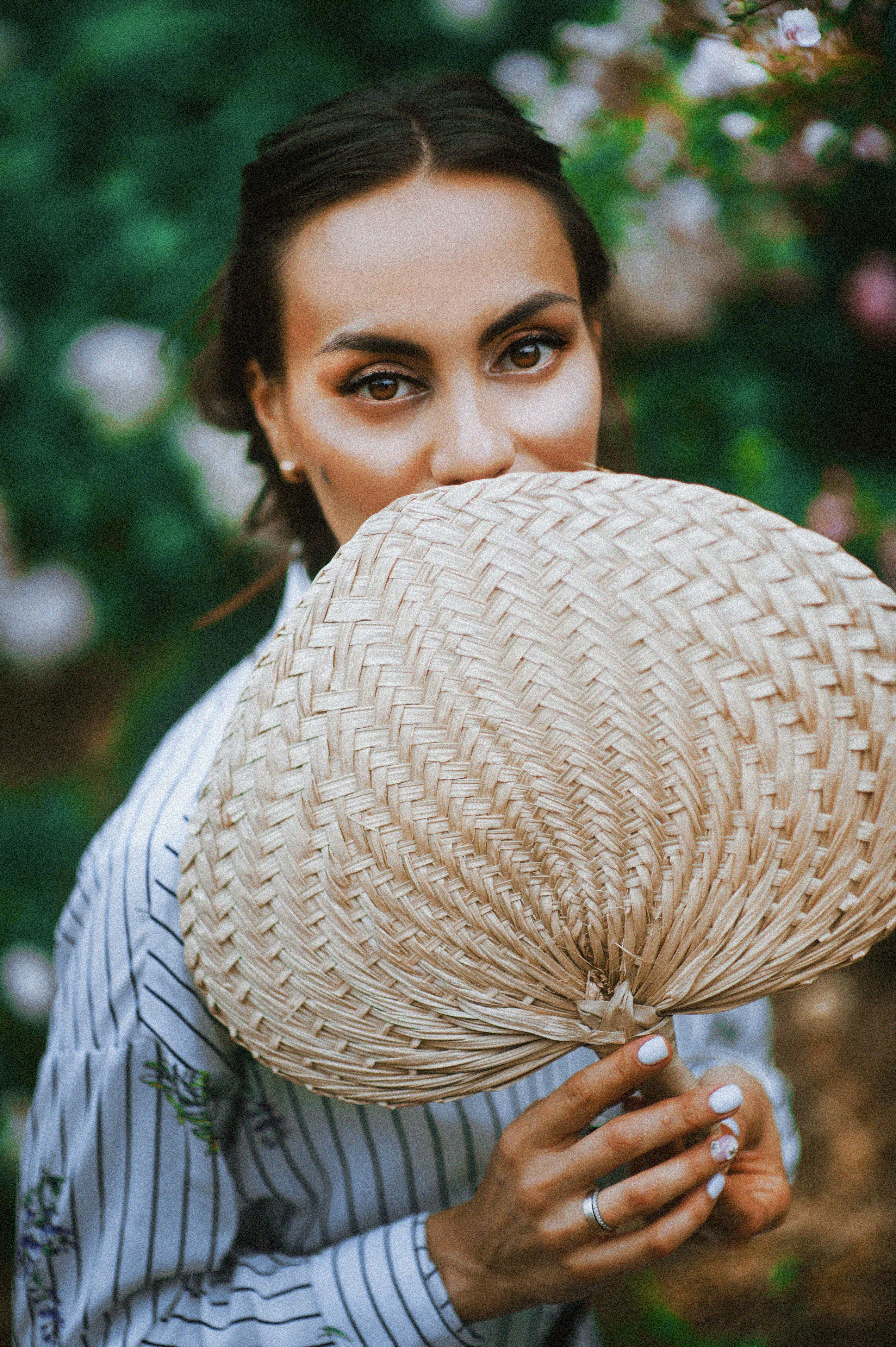 Hidden Smile in the Garden: A Woman with a Handwoven Sunhat