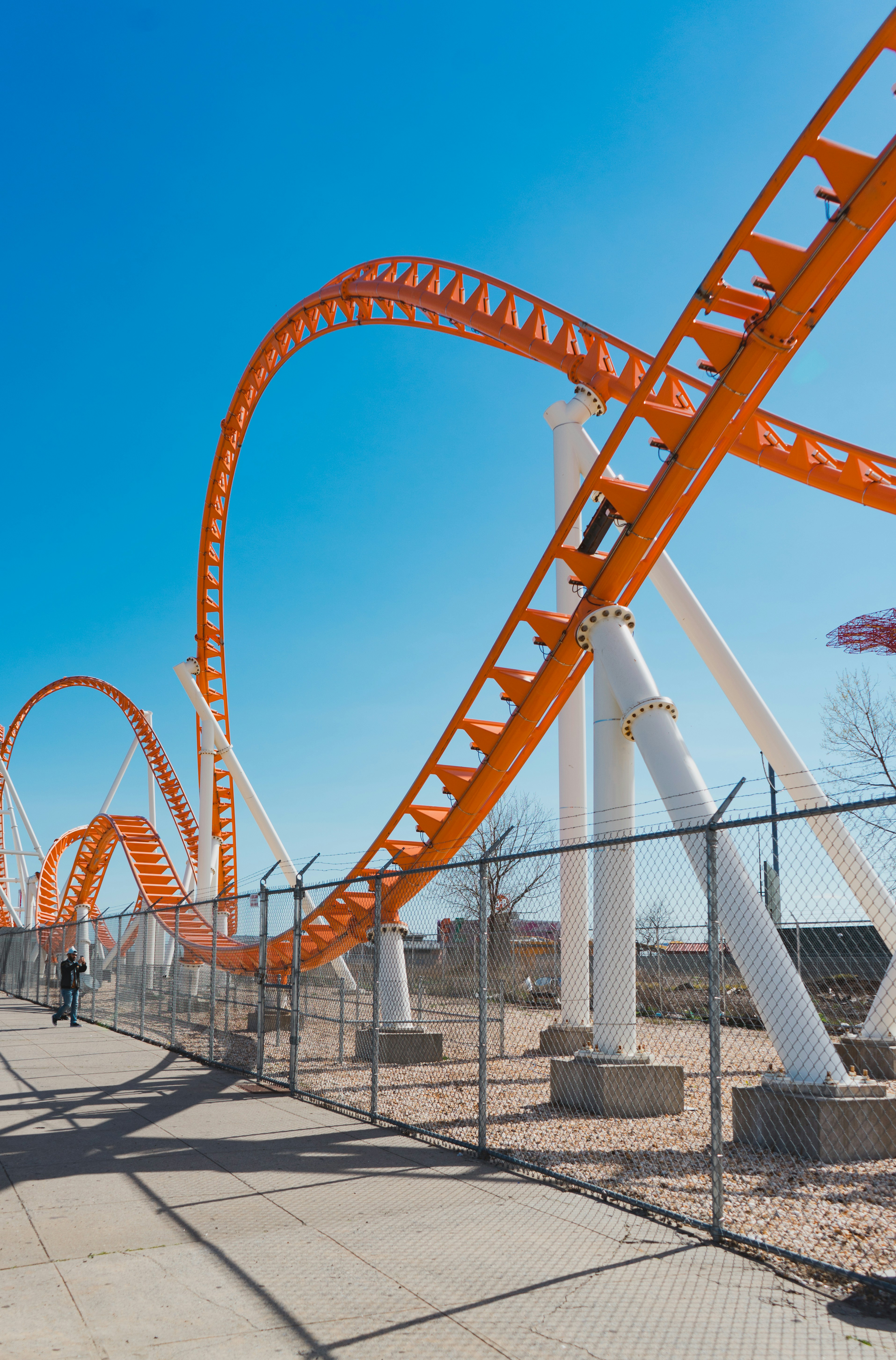 Close-up photography of white and orange roller coaster during daytime ...