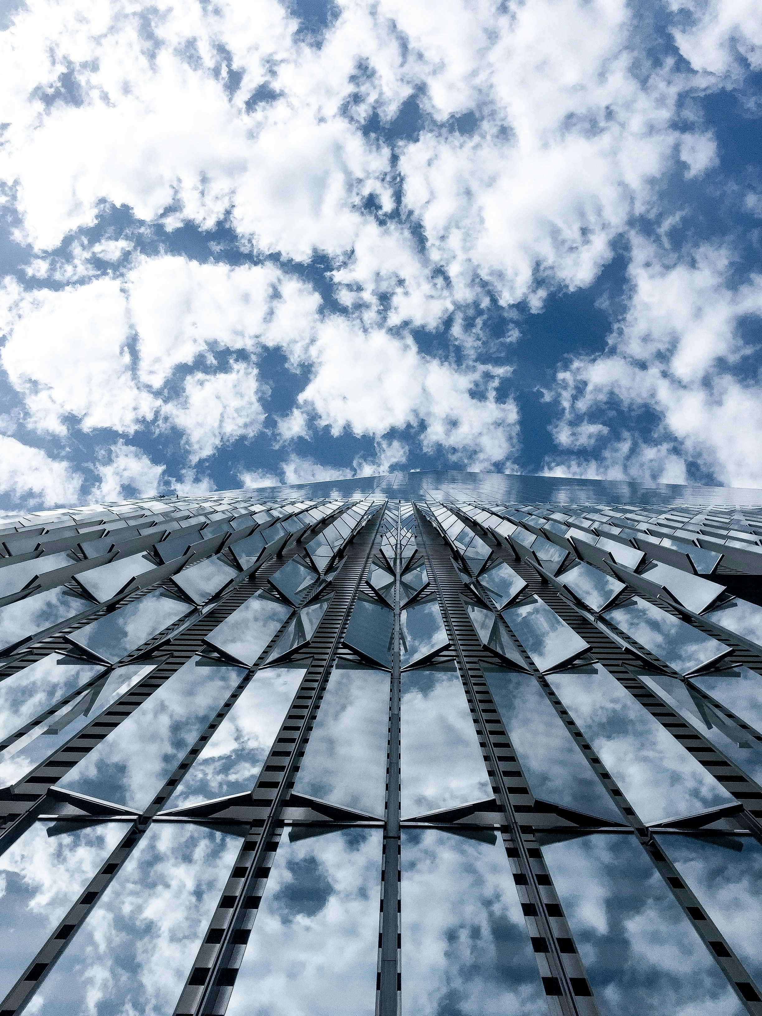 Vanishing Grid: The Glass Tower Reaching for the Clouds
