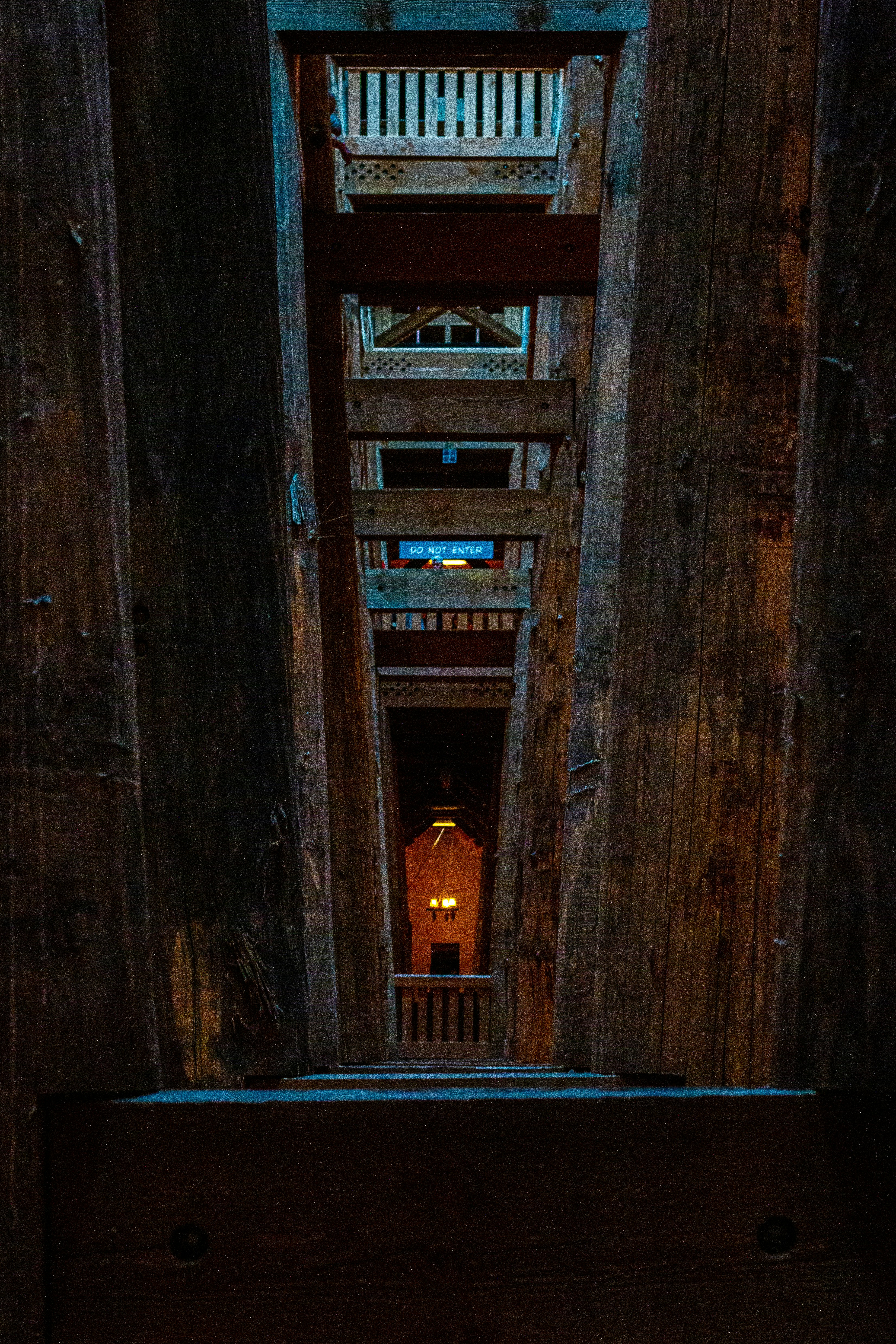 a room with wooden walls and stairs leading to a second floor