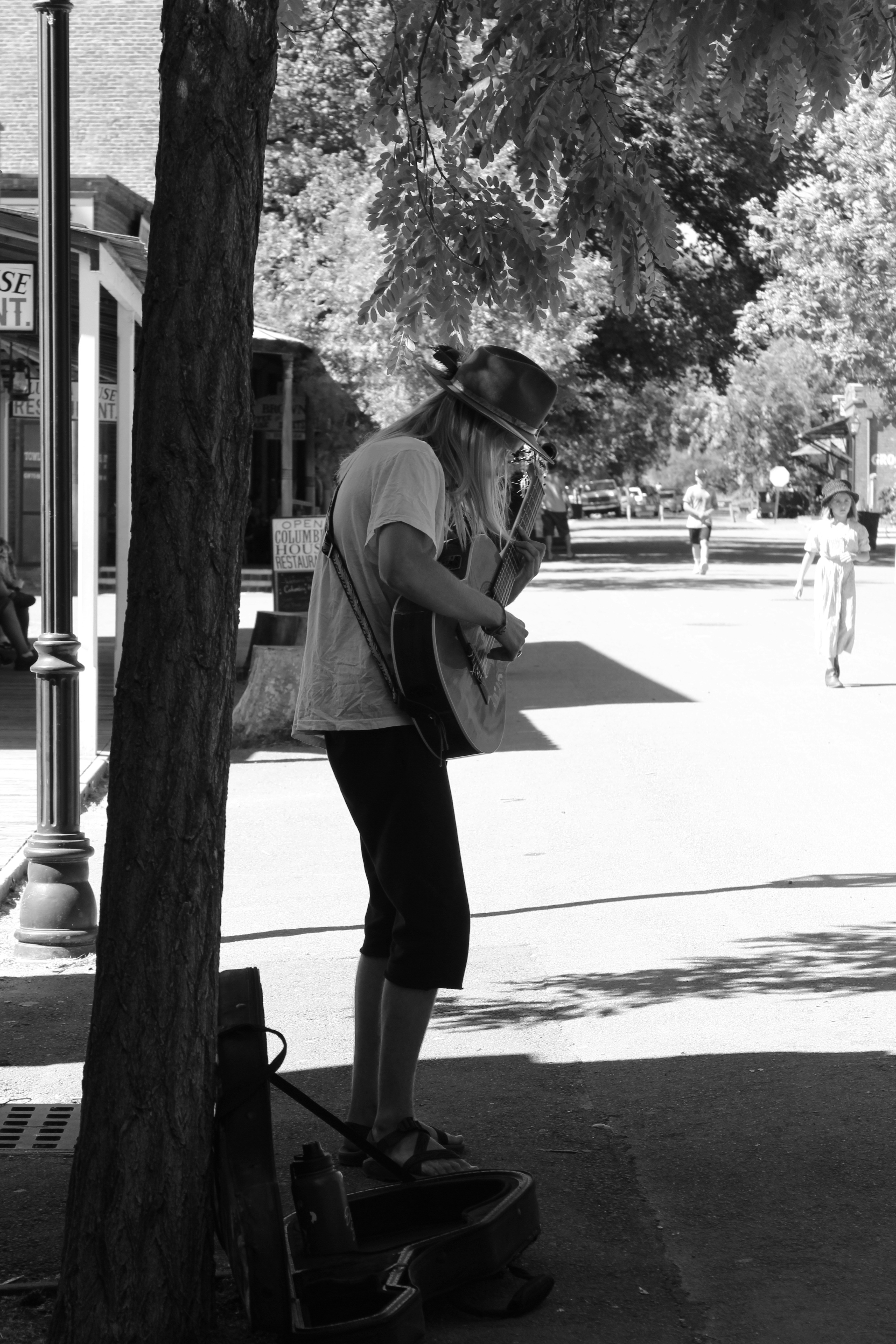 grayscale photography of person playing guitar