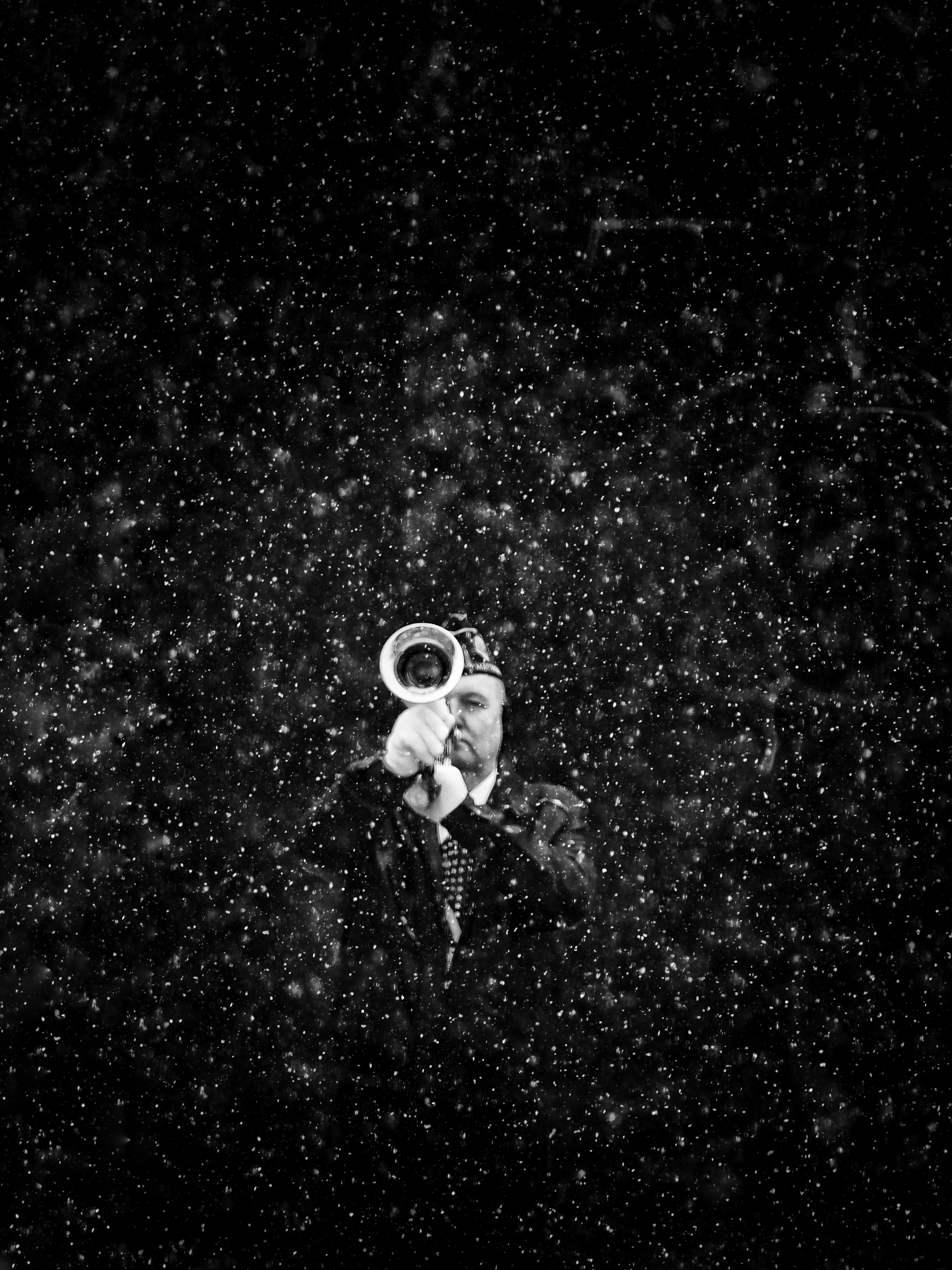a black and white photo of a man in the snow