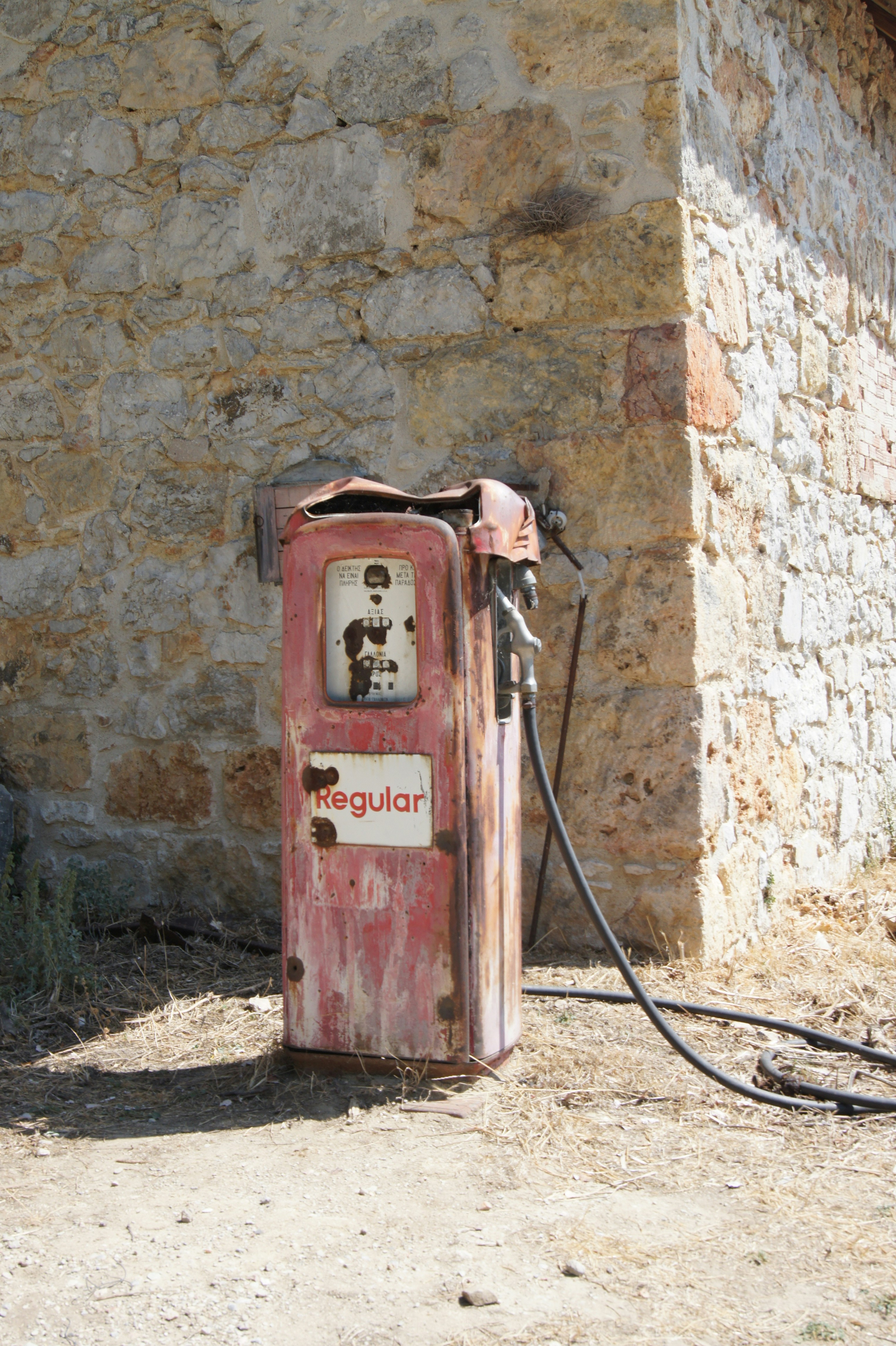 A 1950 Petrol Pump at an abandoned farm. | red gasoline station on focus photography