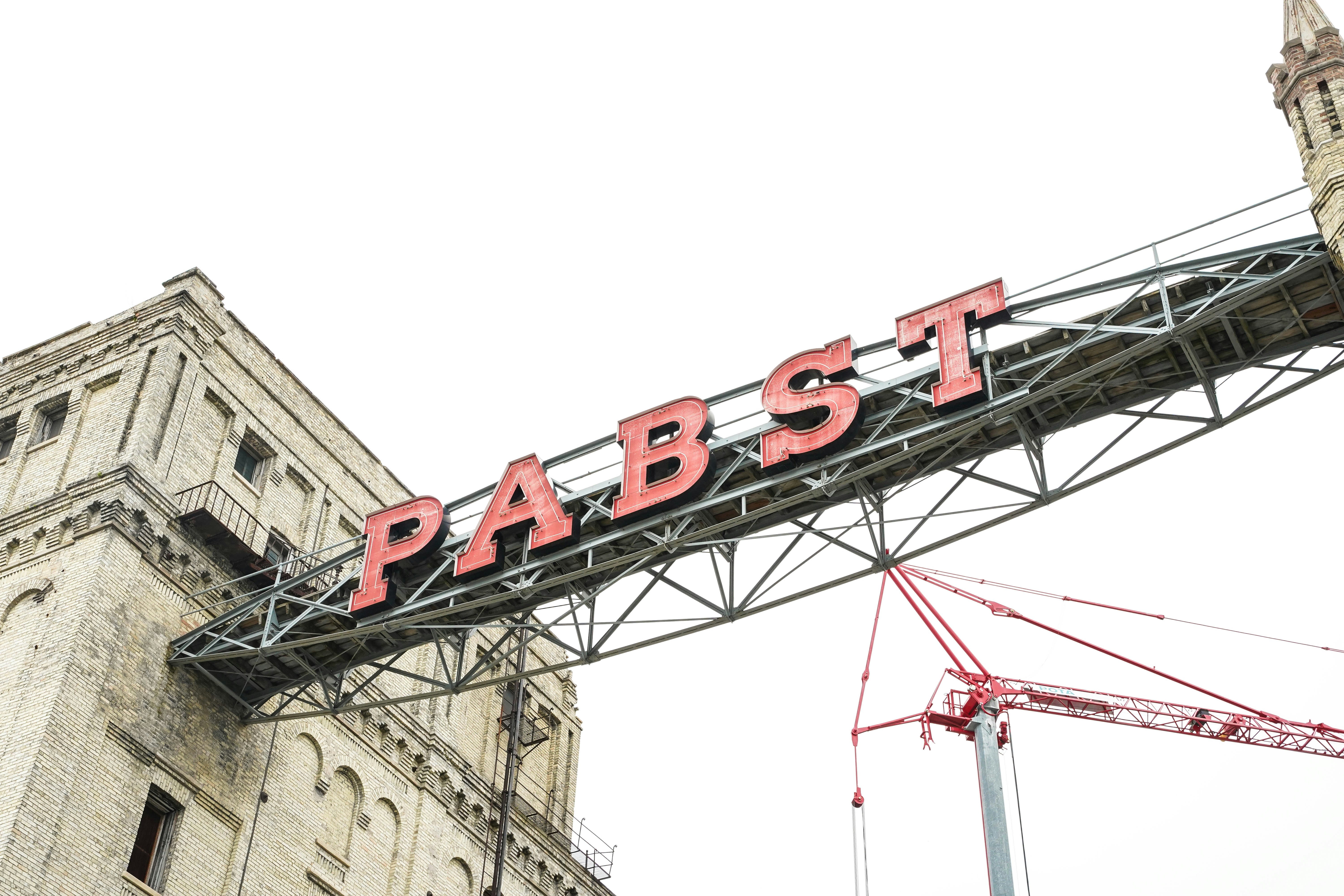 PABST Neon Sign Over Brick Facade with a Construction Crane