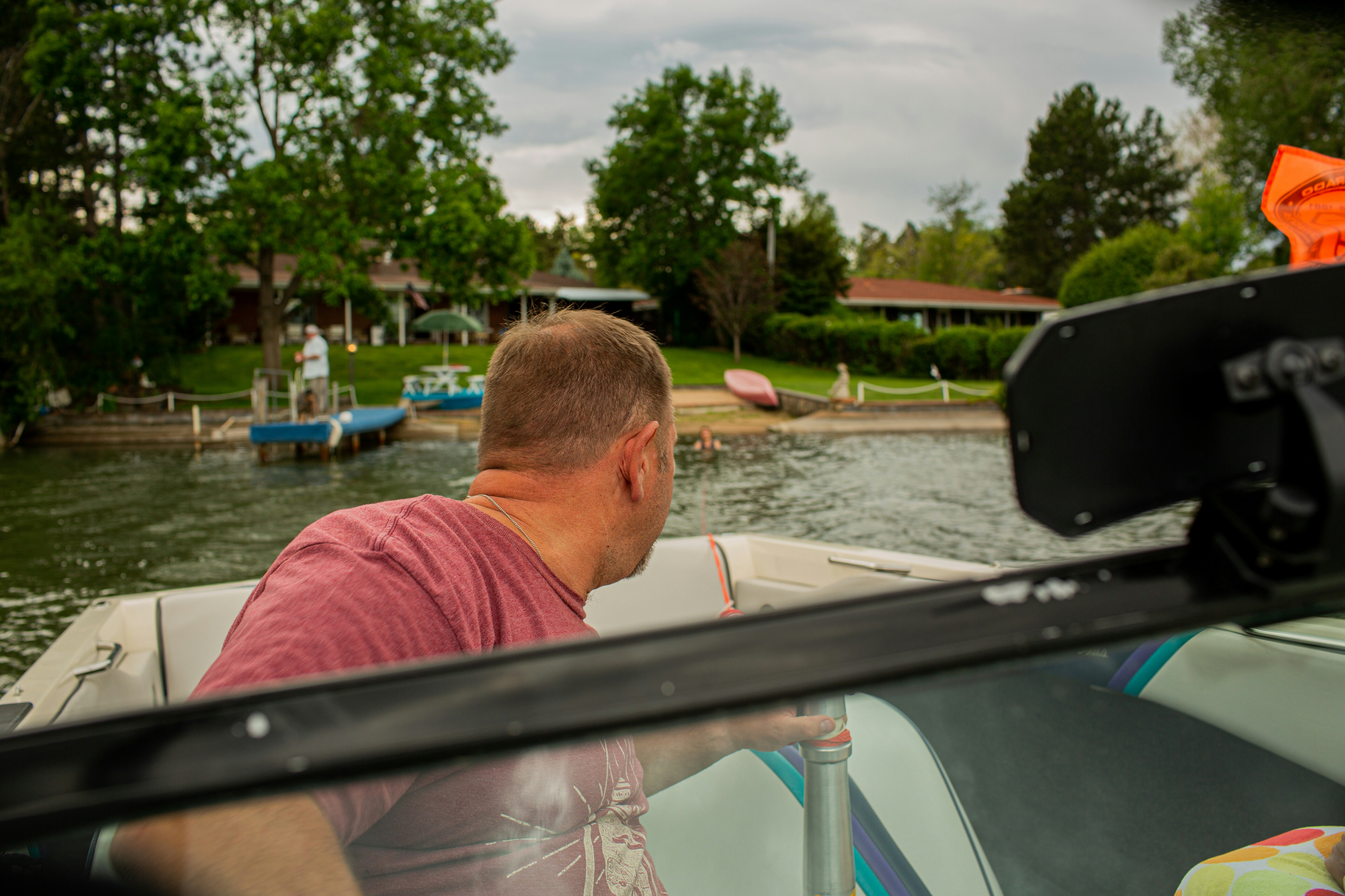 Surfer in a Small Boat: Observation from the Helm as Lakeside Activity Unfolds