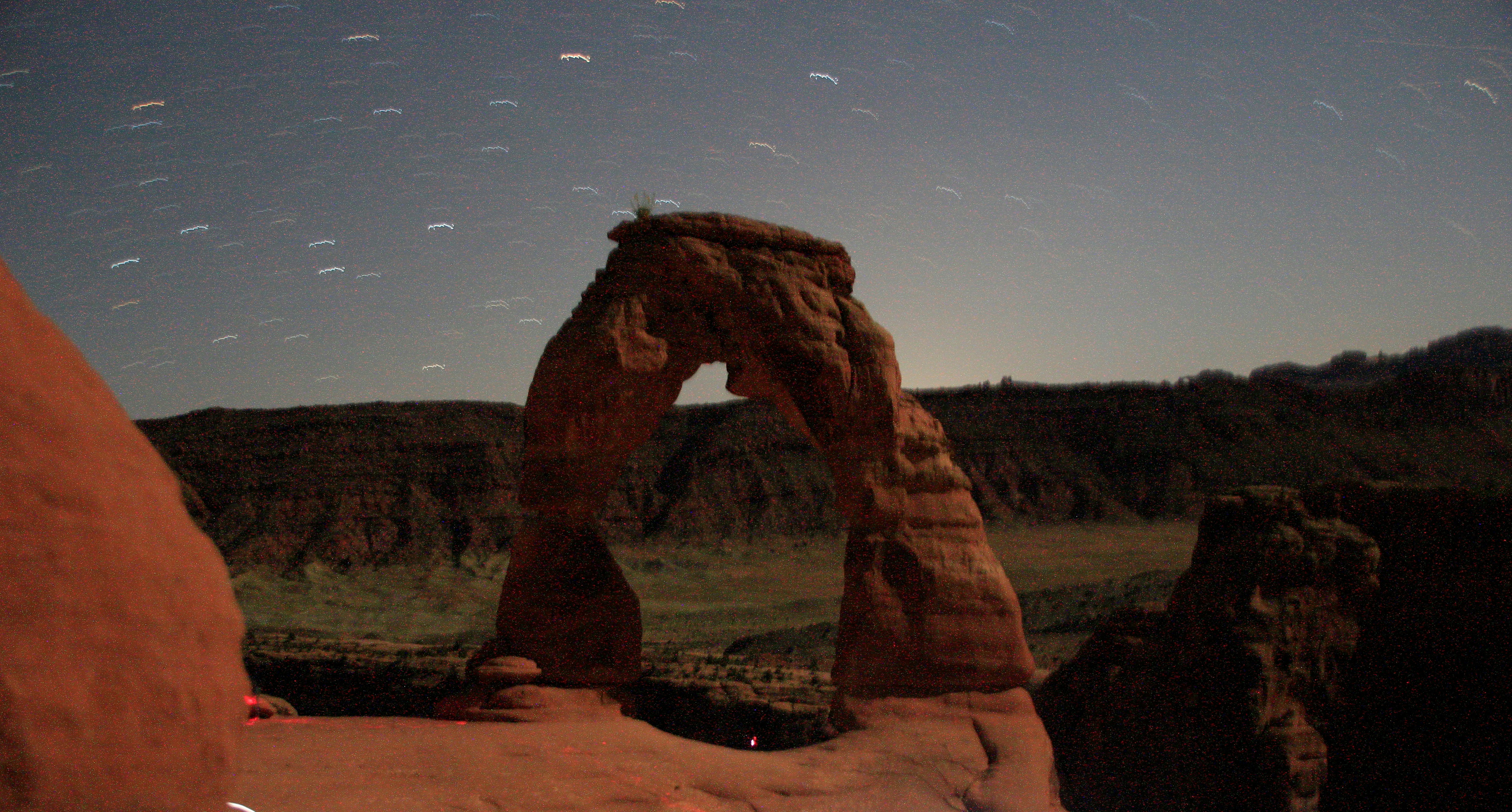 Desert Arc Under a Starry Slipstream