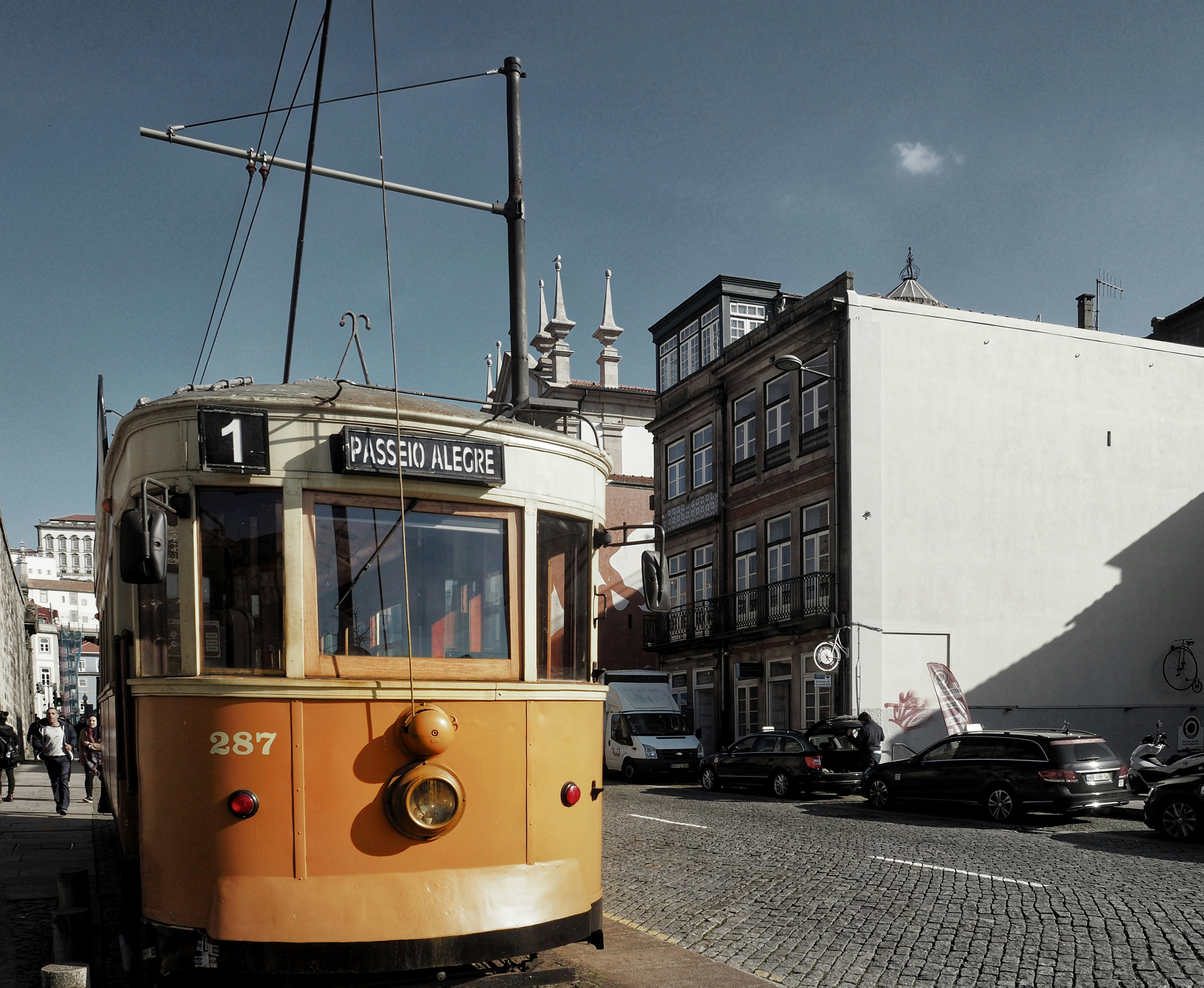 Porto’s Vintage Tram on a Cobbled Street at Golden Hour
