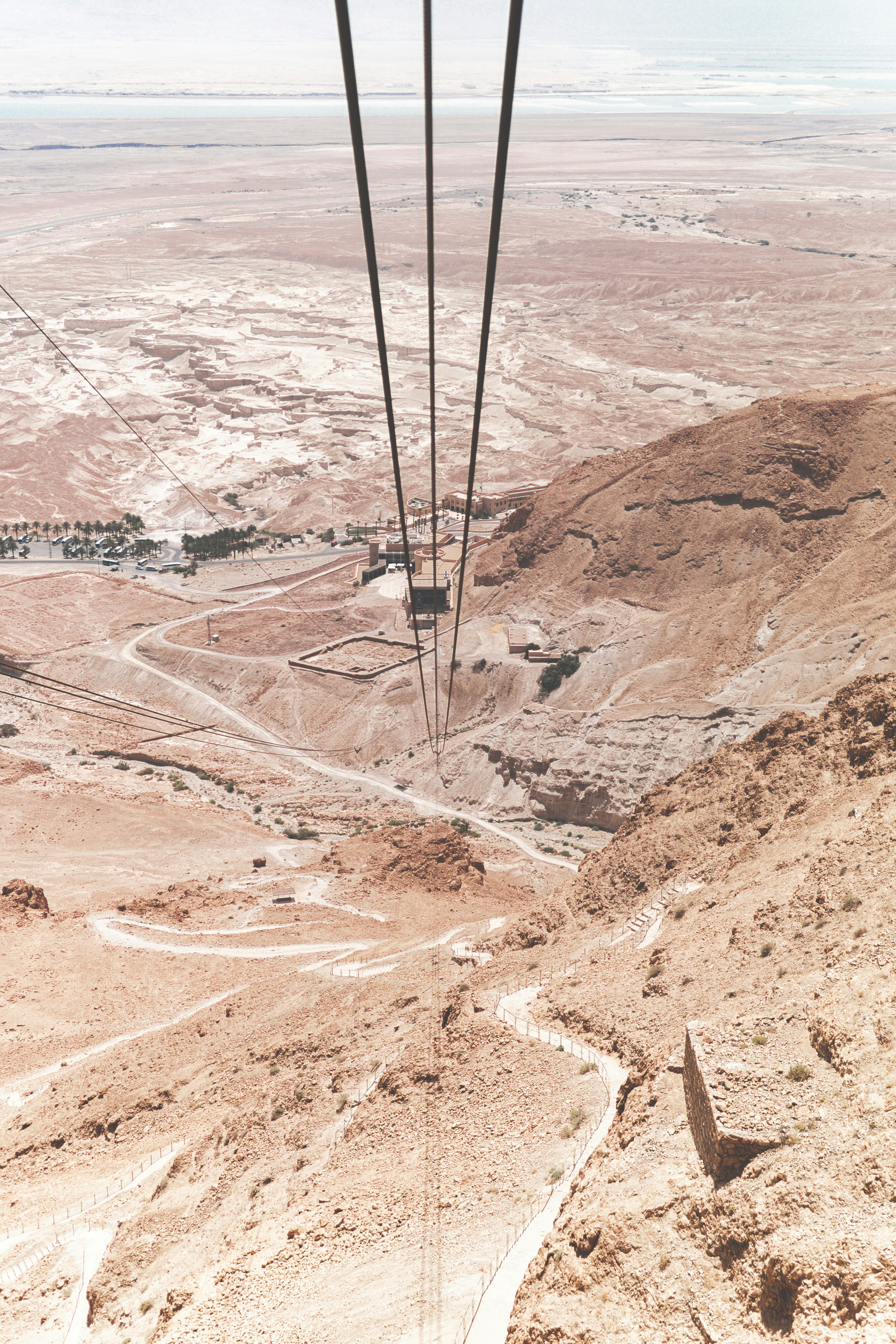 Desert Cableway: Lines of Steel Descend Across a Rust-Red Basin