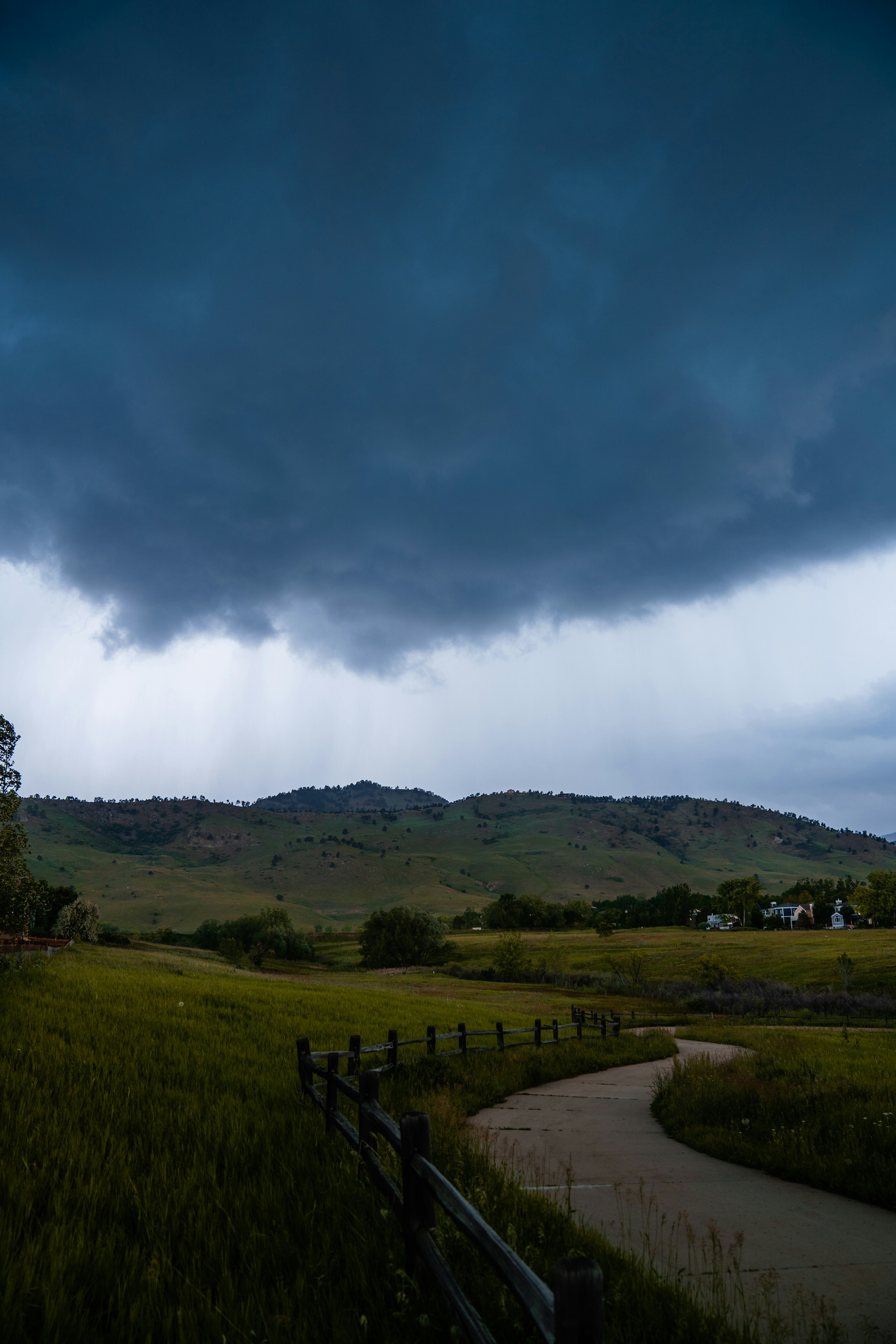 Storm's Edge Over Rolling Hills and Winding Path