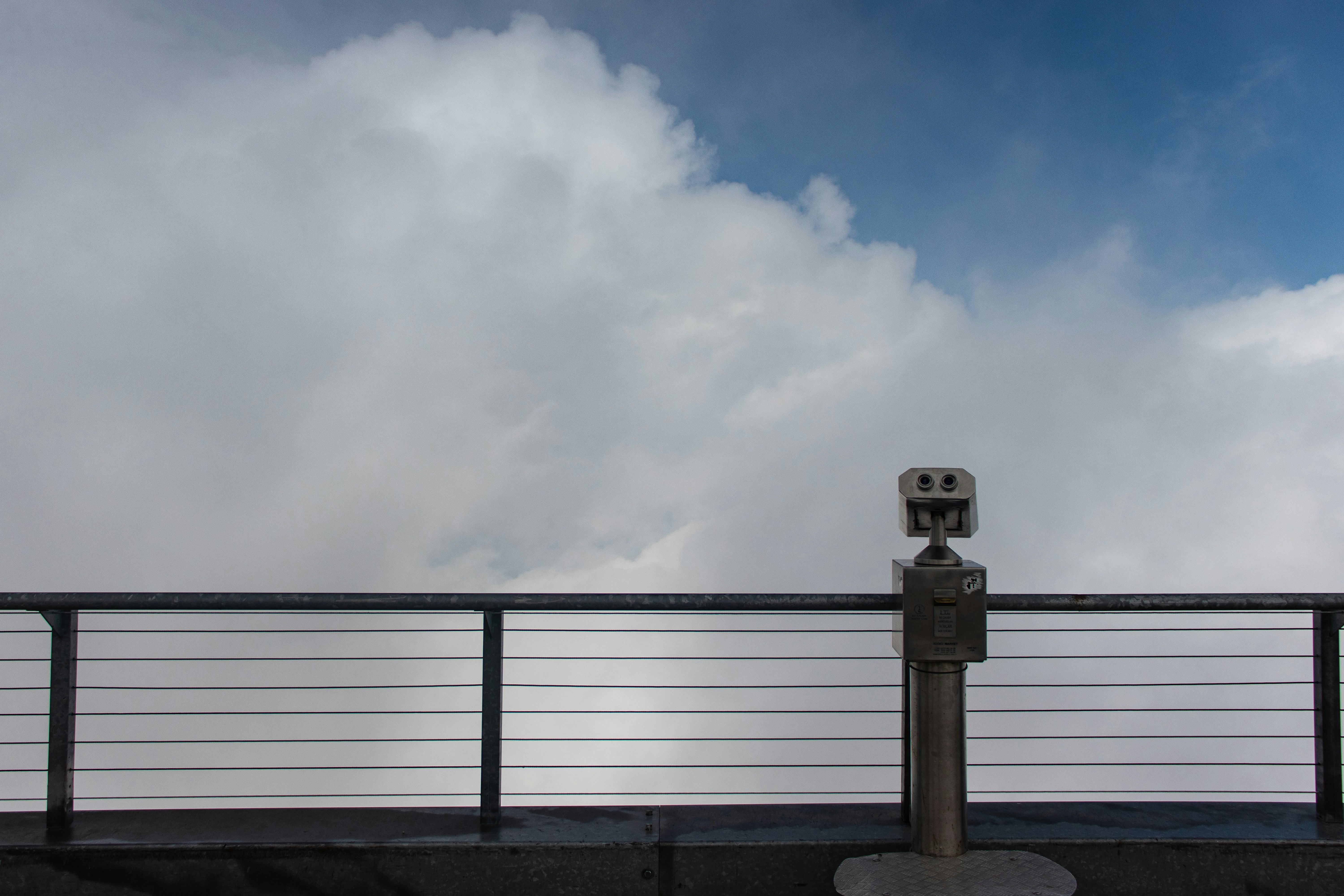 Pier Sentinel: A lone coin-operated telescope guards a cloud-swept horizon