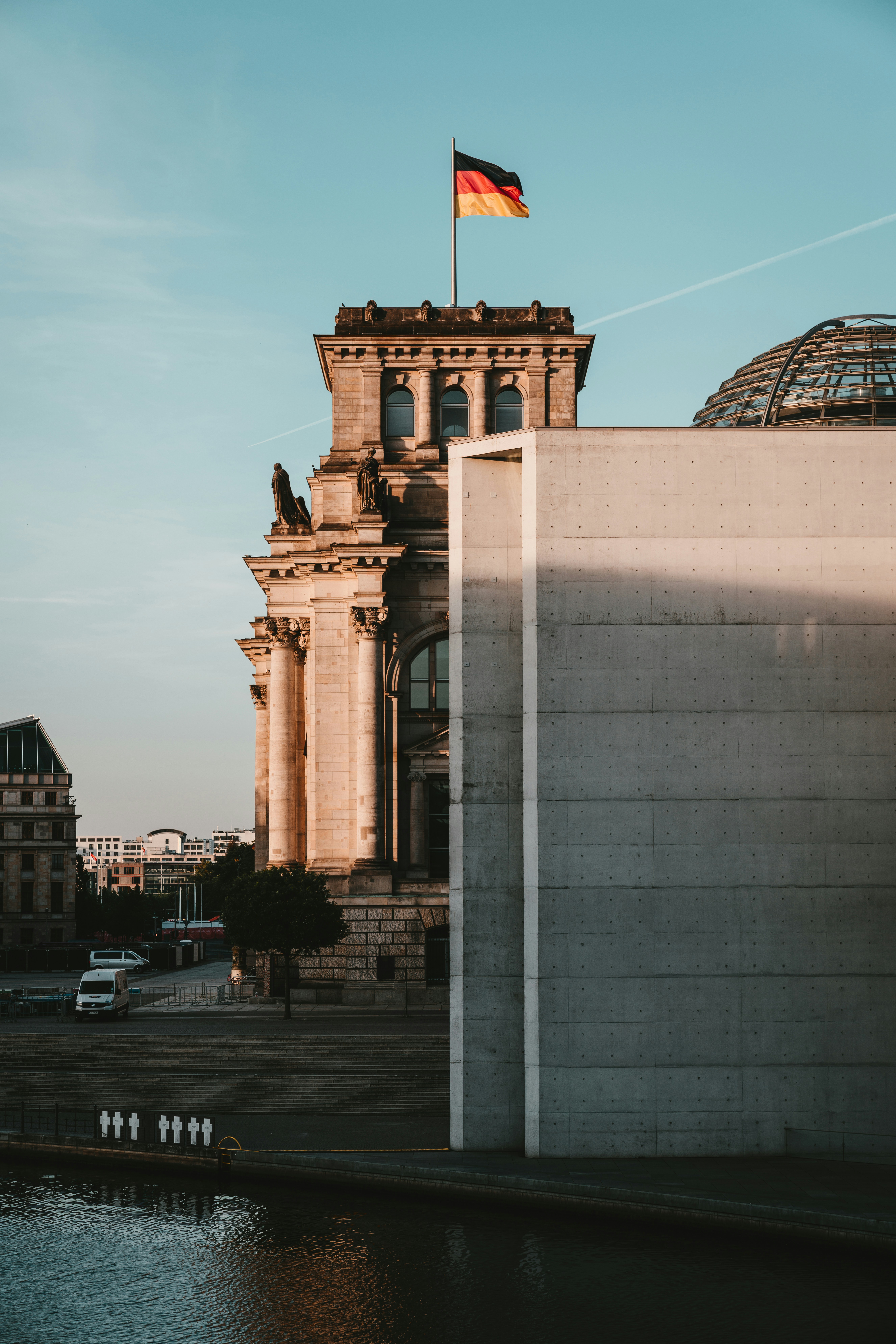 Flag atop the historic façade guarding the glass dome