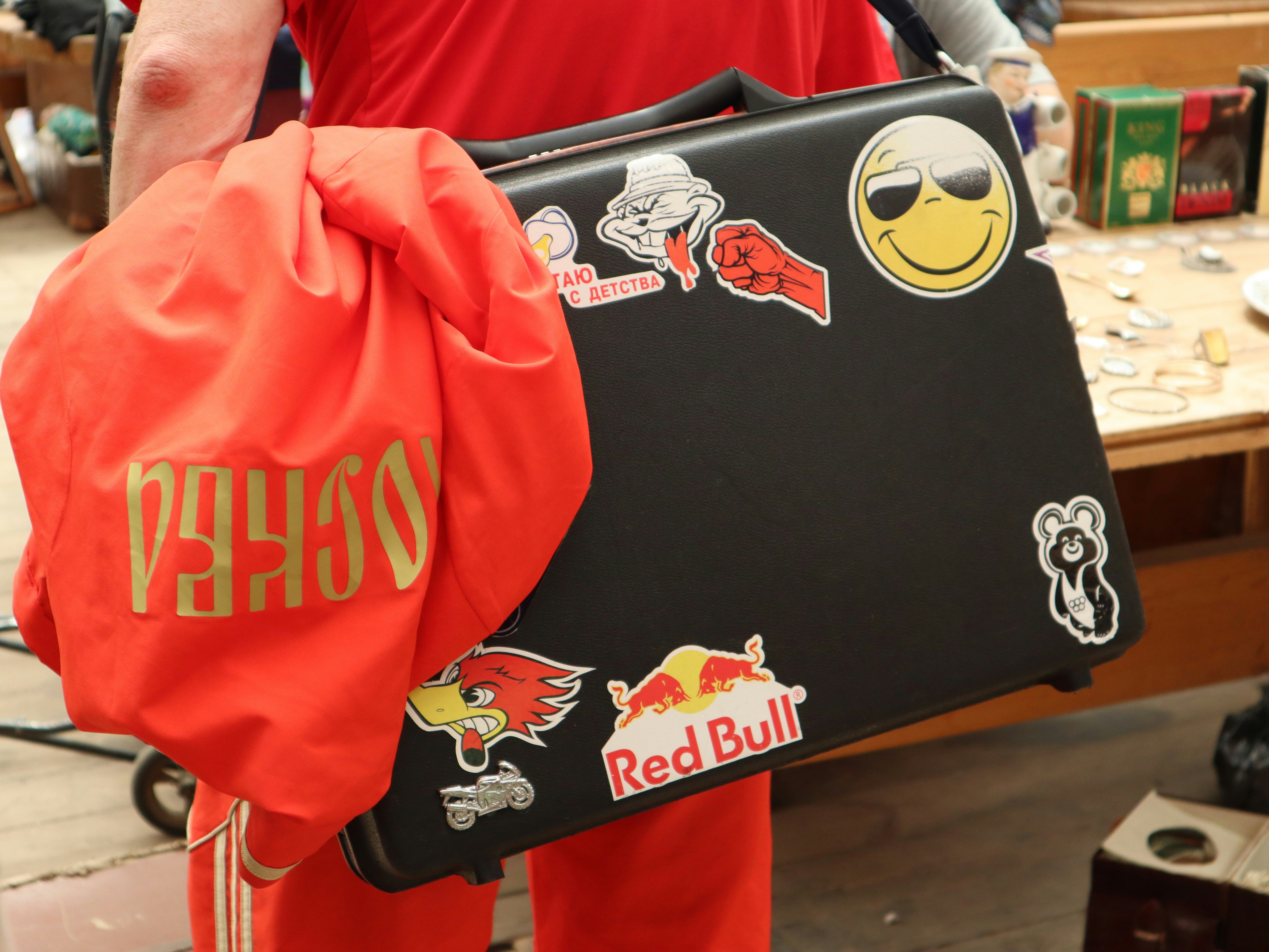 Stickered Laptop in a Red-Bag Showcases Personal Style