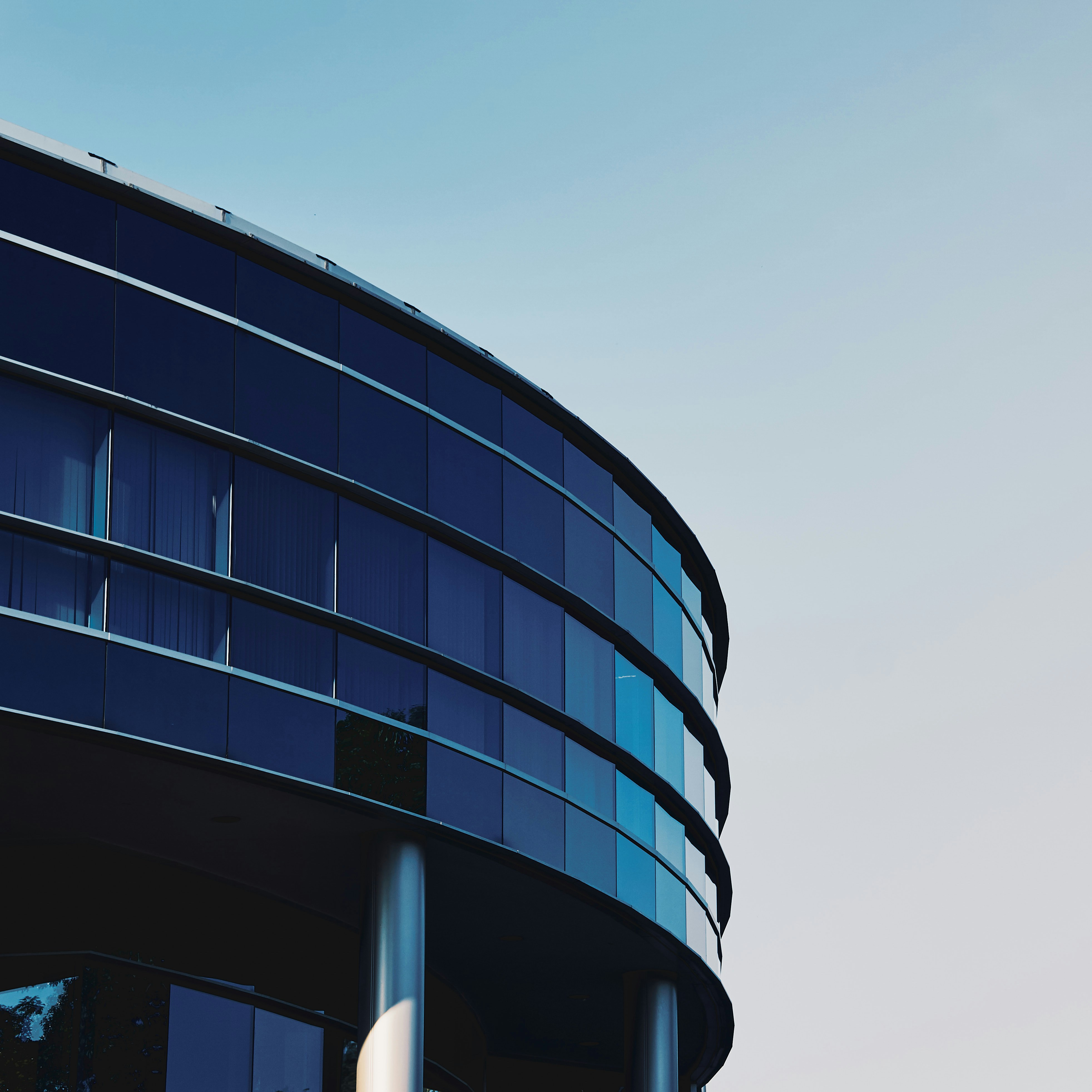 Curve of Glass: A Modern Facade in Soft Twilight