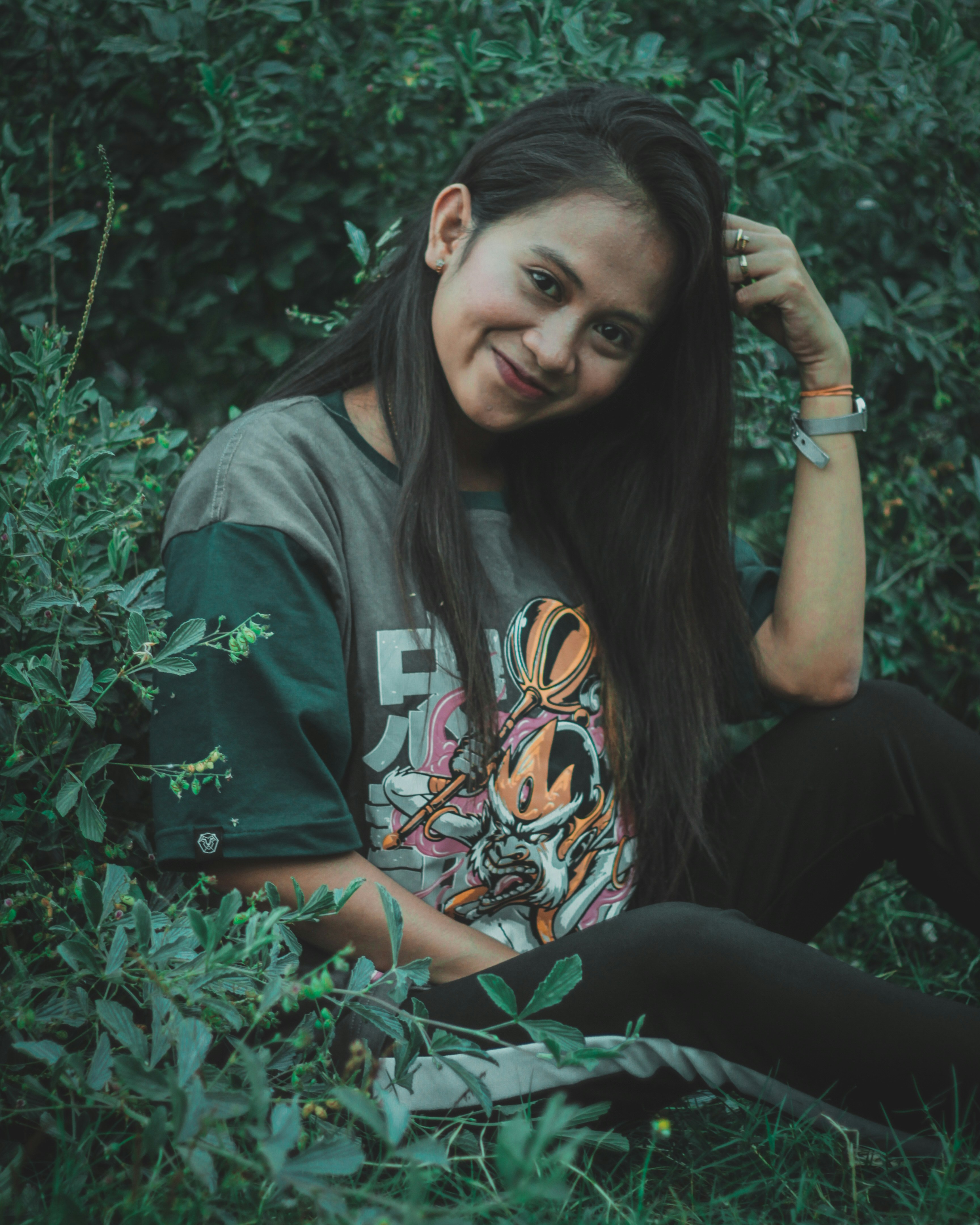 Woman smiling sitting on green-leafed plant photo – Free Grey Image on ...