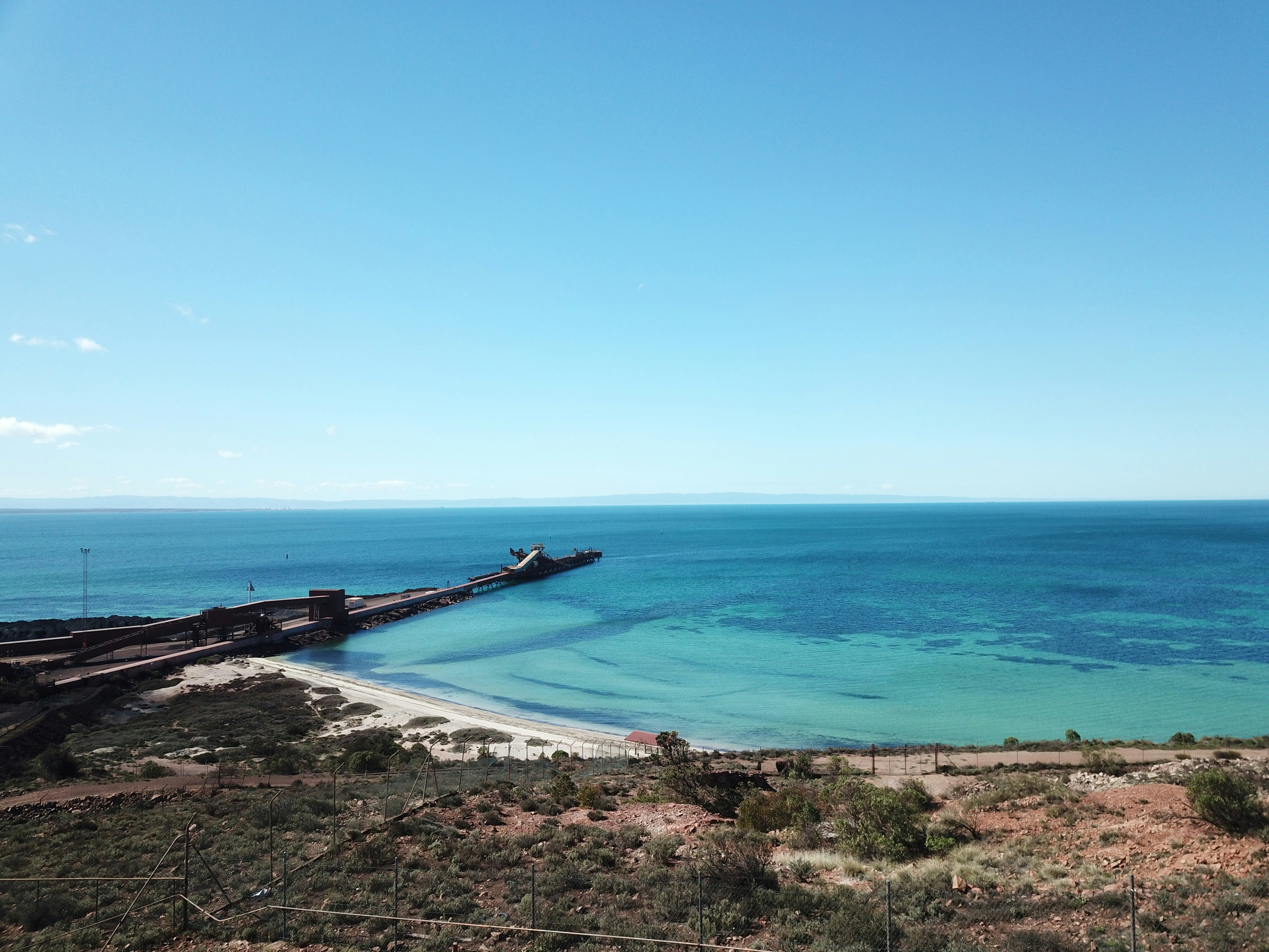 Cerulean Break: A Silent Pier Reaches Toward the Open Sea