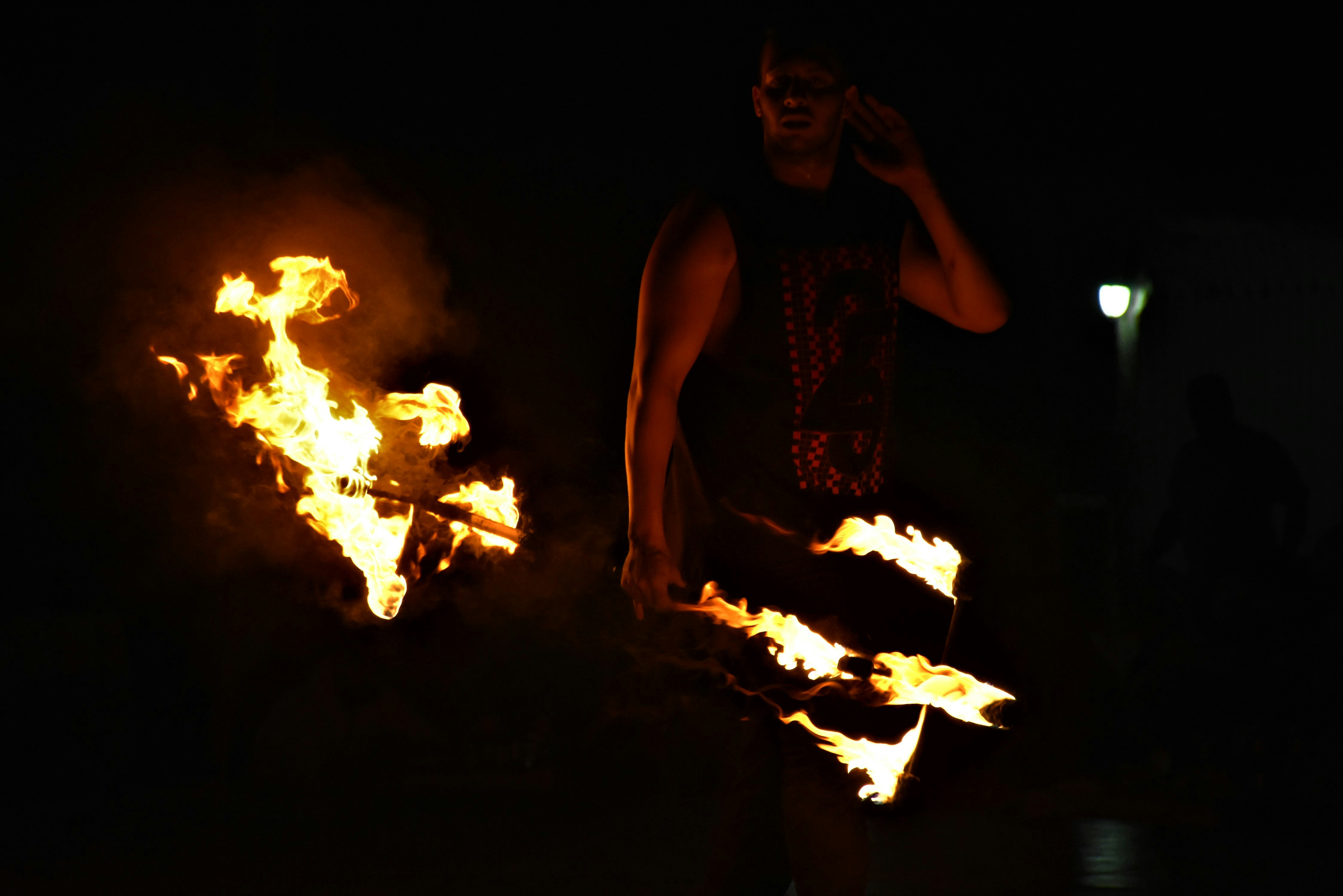 Man holding fire rod during nighttime photo – Free Fire Image on Unsplash