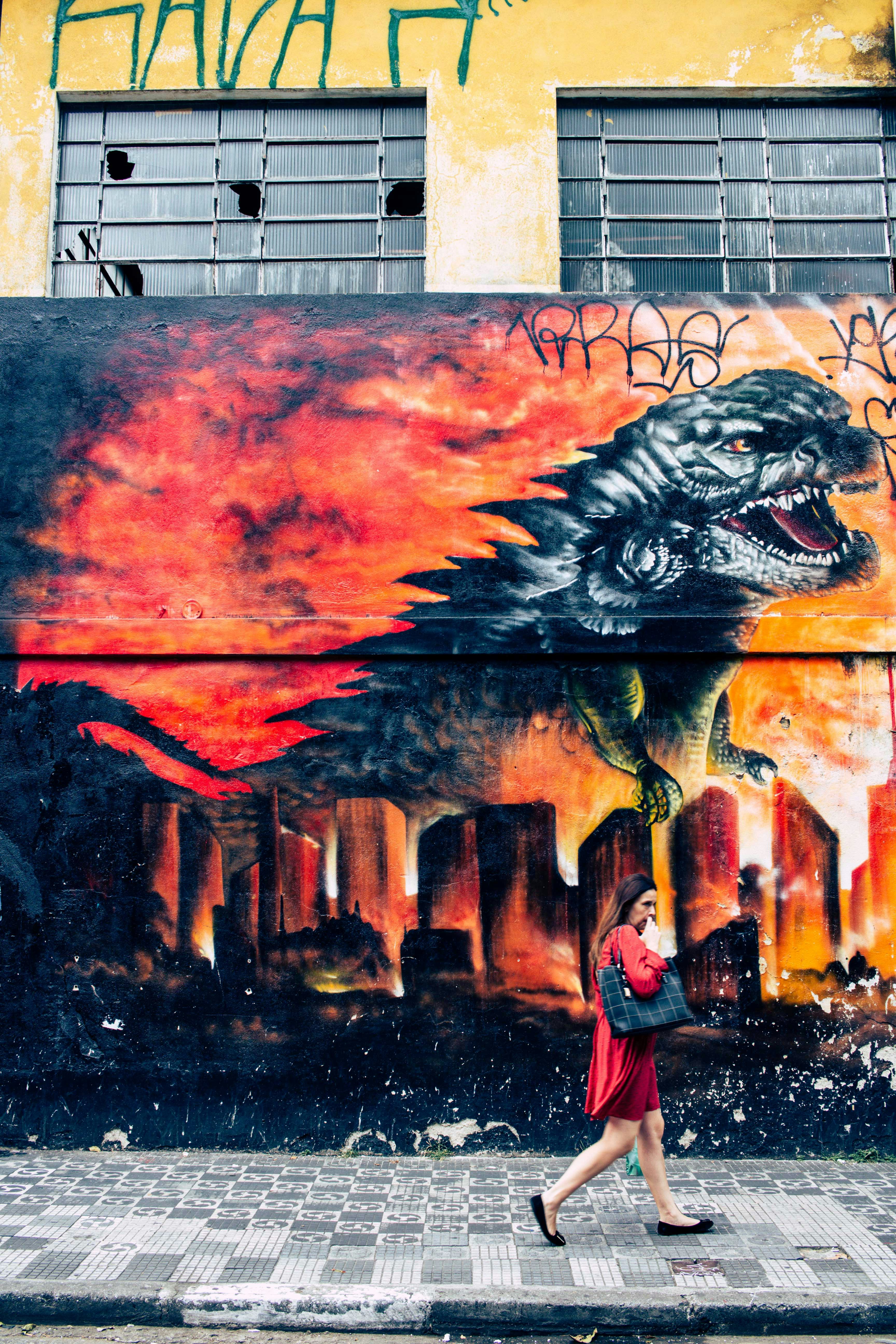 Flame Wall: A Red-Dressed Moment Under a Dragon Graffiti