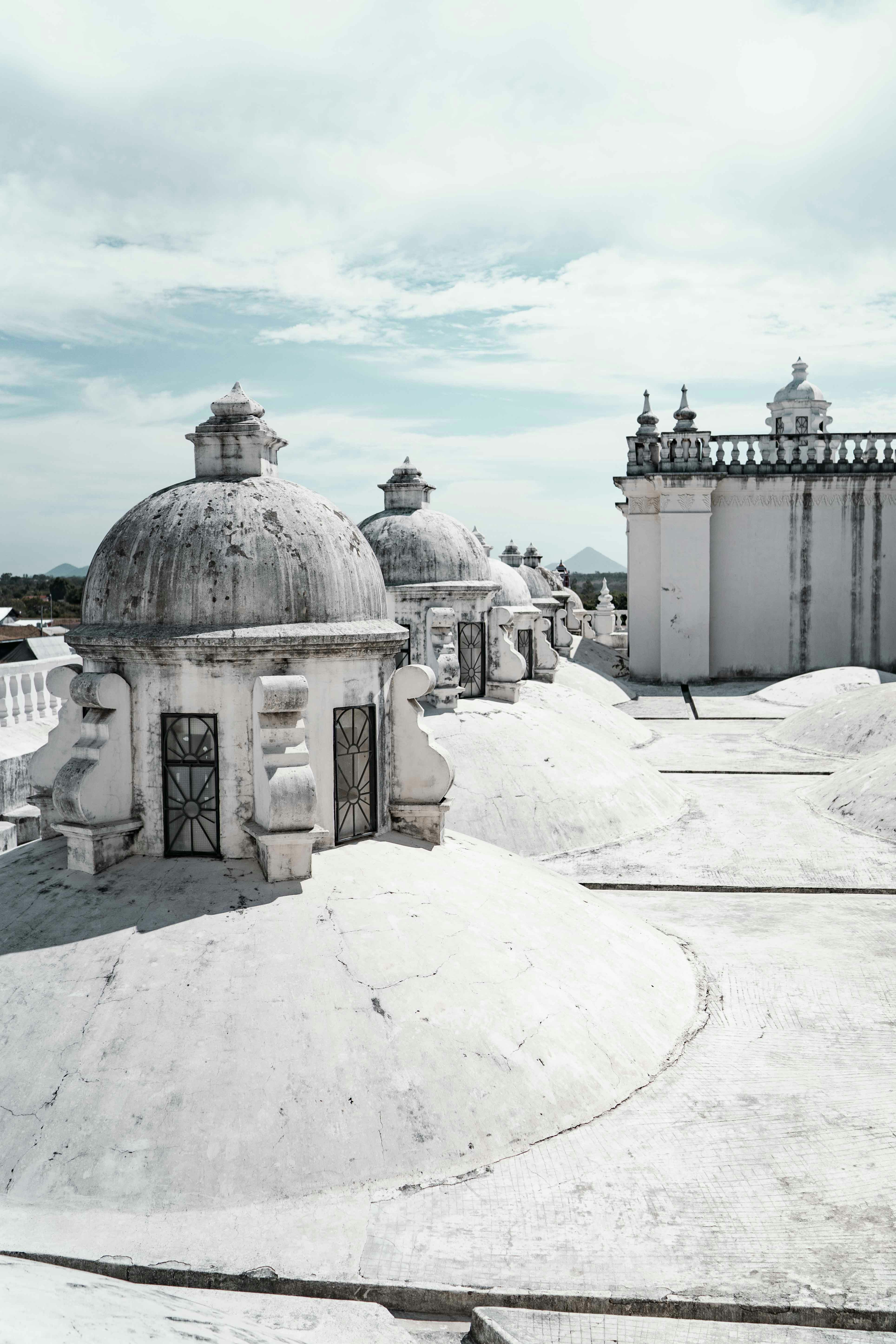 White Domes on a Sunlit Terrace Under a Sky of Soft Clouds