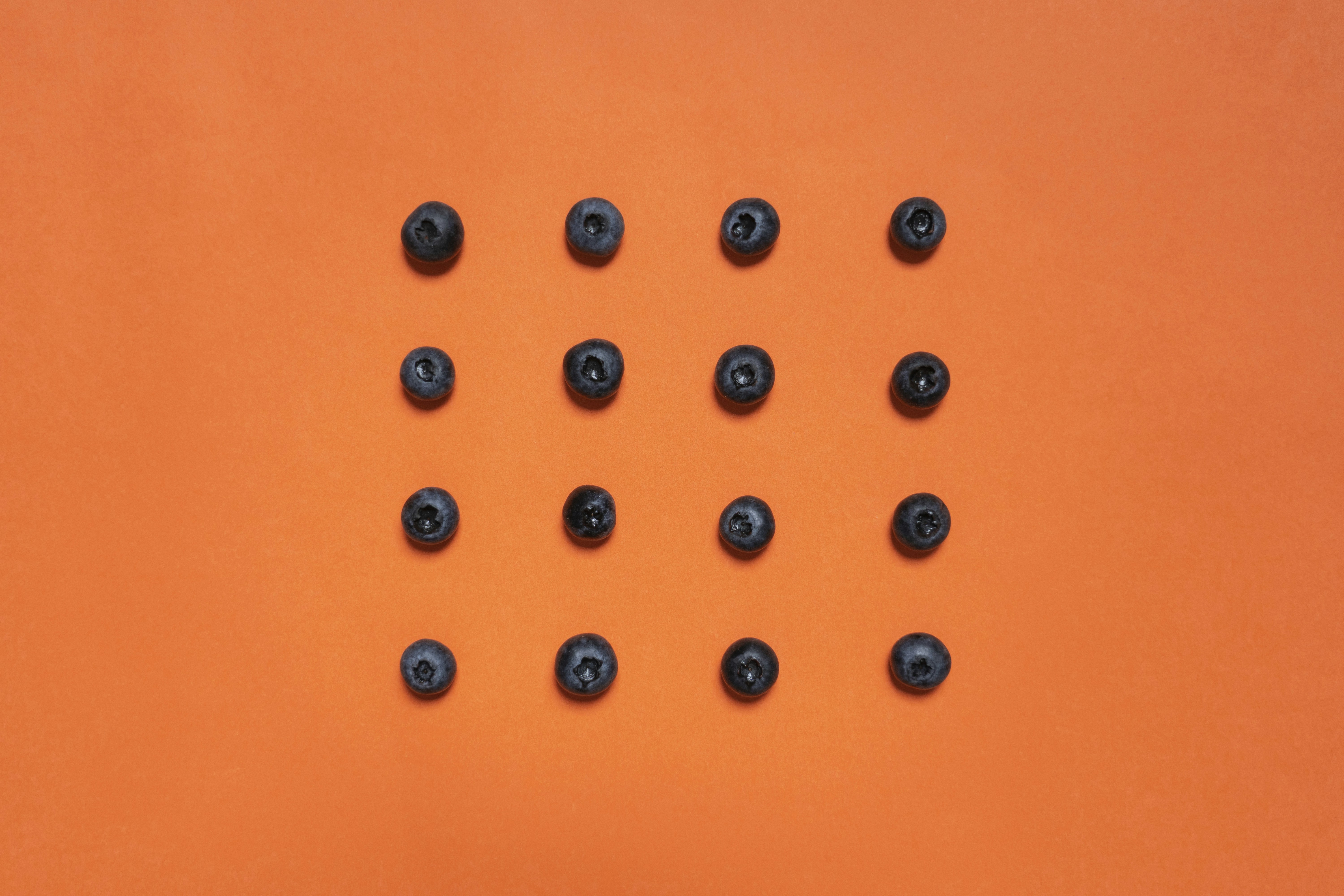 Drop-in Grid: Evenly Spaced Nuts on Bold Orange